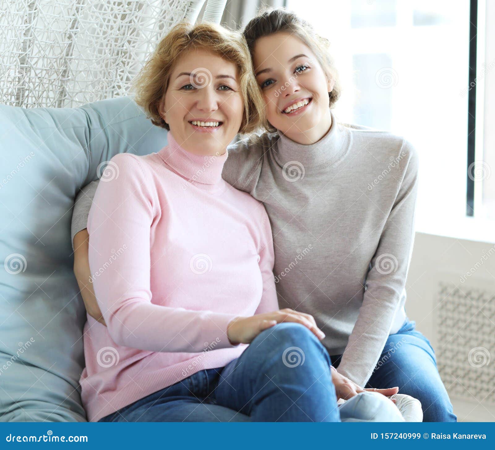 Beautiful Senior Mom And Her Adult Daughter Are Hugging Looking At