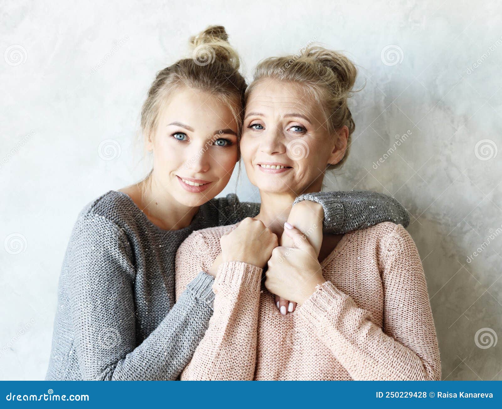 Beautiful Senior Mom And Her Adult Daughter Are Hugging Looking At
