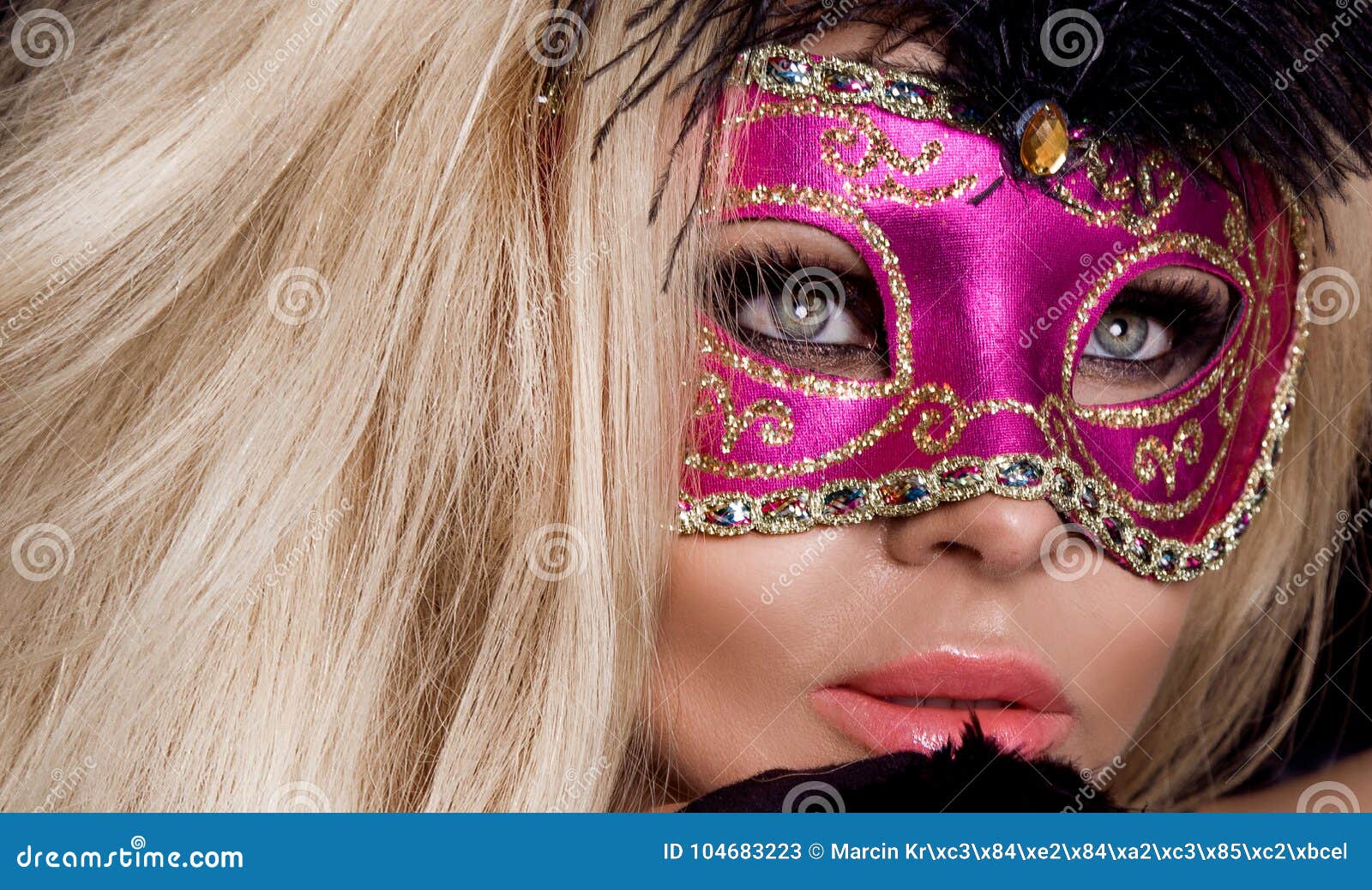Beautiful Sensual Blonde Woman With Carnival Mask Standing On A