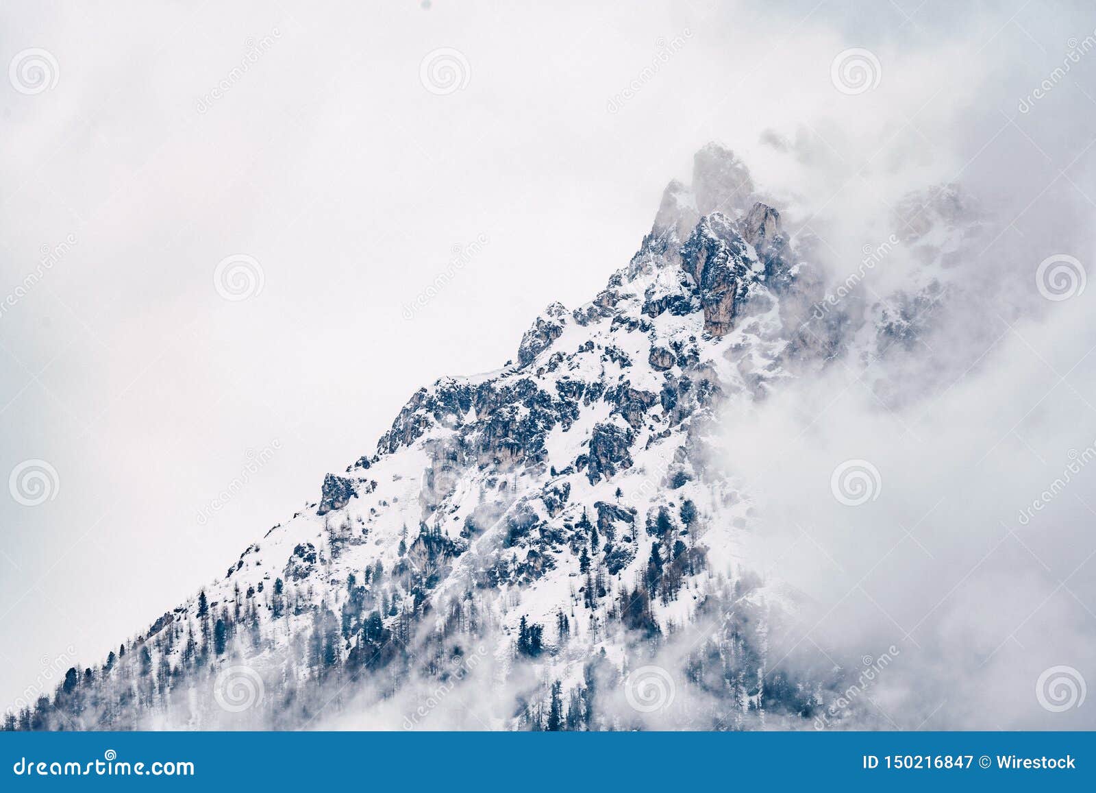 Beautiful Shot of a Cloudy Mountain Covered in Snow with Grey Sky Stock ...