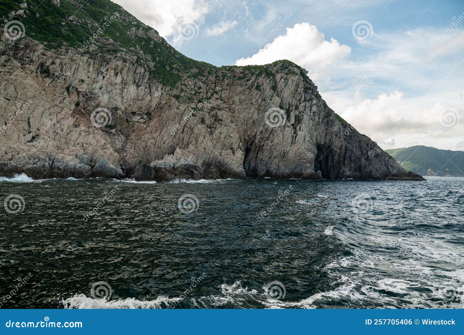 Beautiful Shot of a Huge Cliff in a Sea Under the Blue Sky Stock Photo ...
