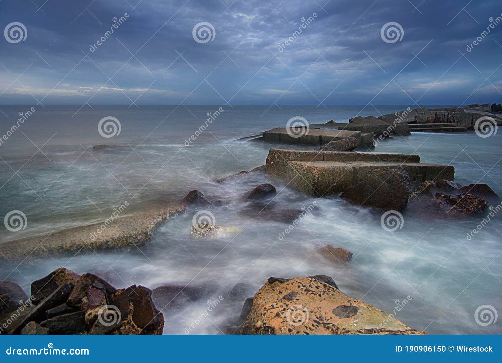 Beautiful Shot of Ocean Waves Crashing on Rocks Under a Cloudy Sky ...
