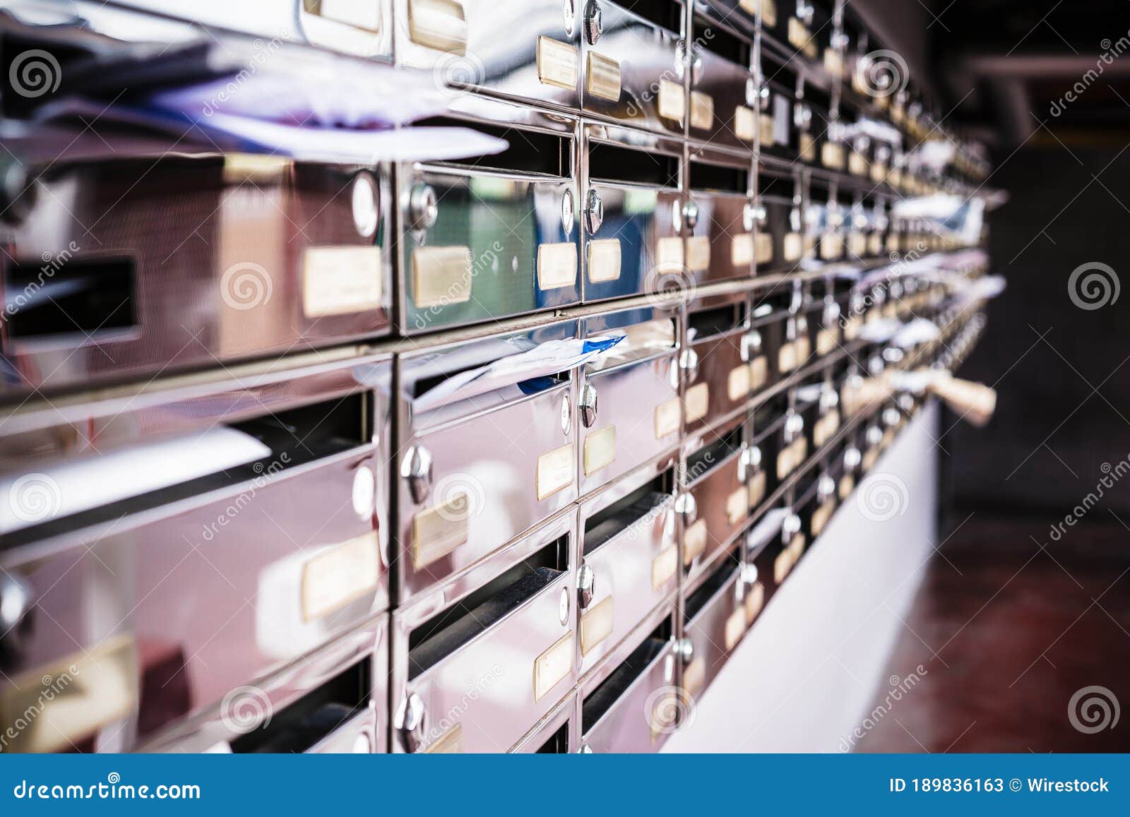 Beautiful Shot of Rows of Shiny Silver Mailboxes with Some Envelopes ...