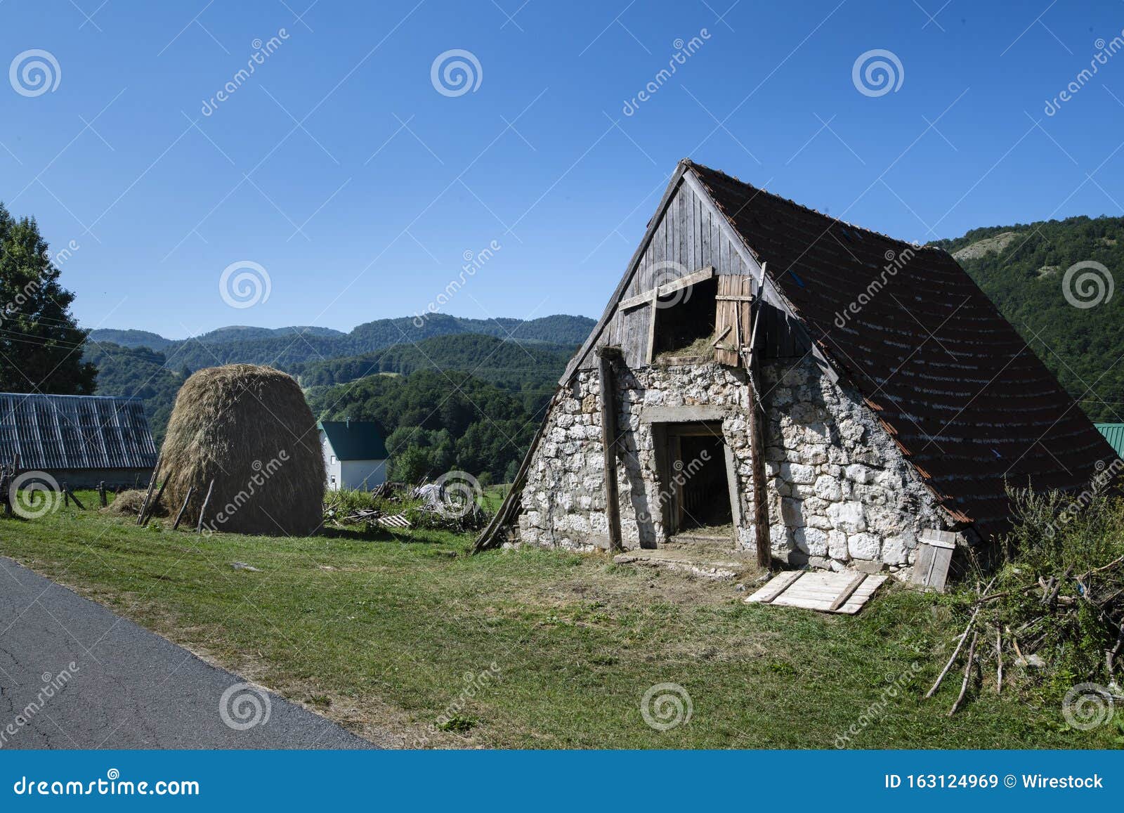 Beautiful Shot of a Small Triangular Stone Barn in a Rural Area and the ...