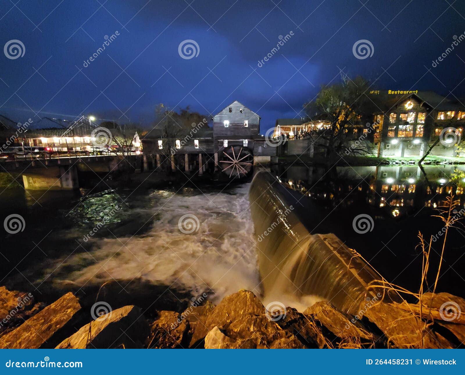 Beautiful Shot of a Waterfall Next To a Watermill Building Stock Image ...