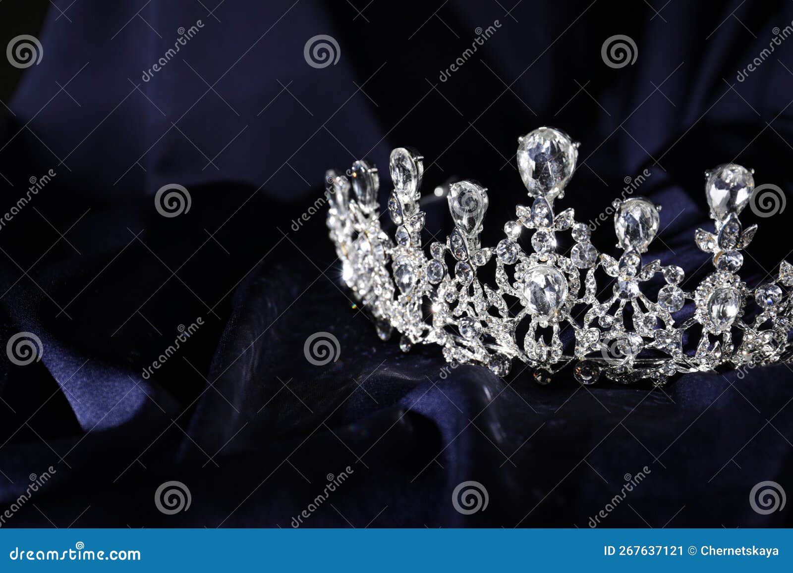 Beautiful Silver Tiara with Diamonds on Dark Blue Cloth. Space for Text ...