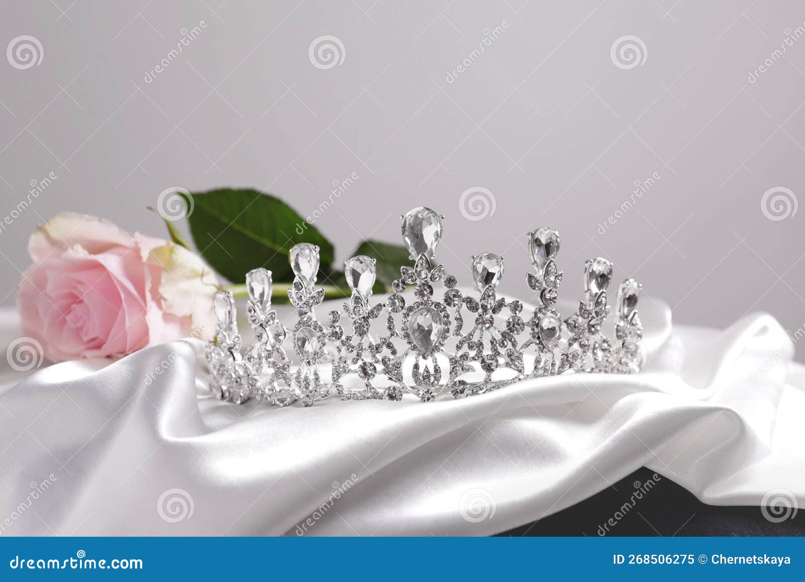 Beautiful Silver Tiara with Diamonds and Rose on White Silk Cloth Stock ...