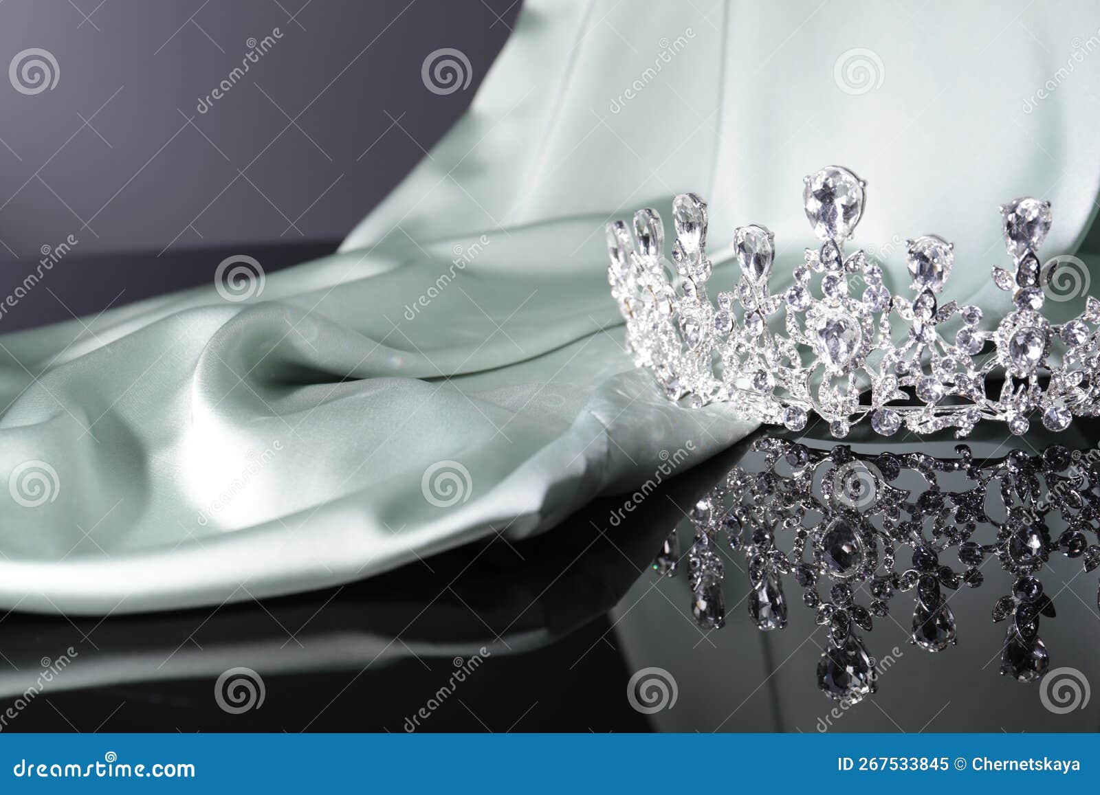 Beautiful Silver Tiara with Gems Near Light Cloth on Dark Mirror ...