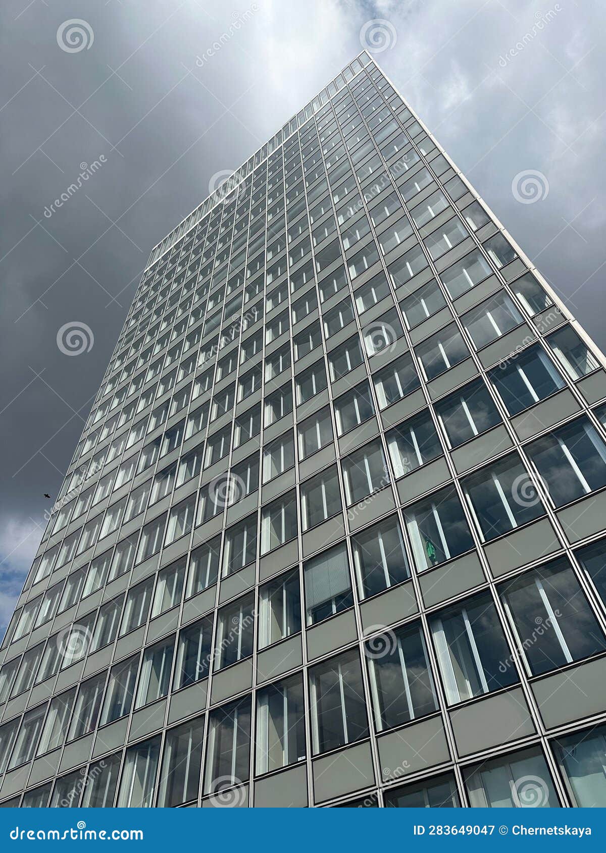 A Beautiful Old Skyscraper With A Spire Can Be Seen Behind The Houses ...