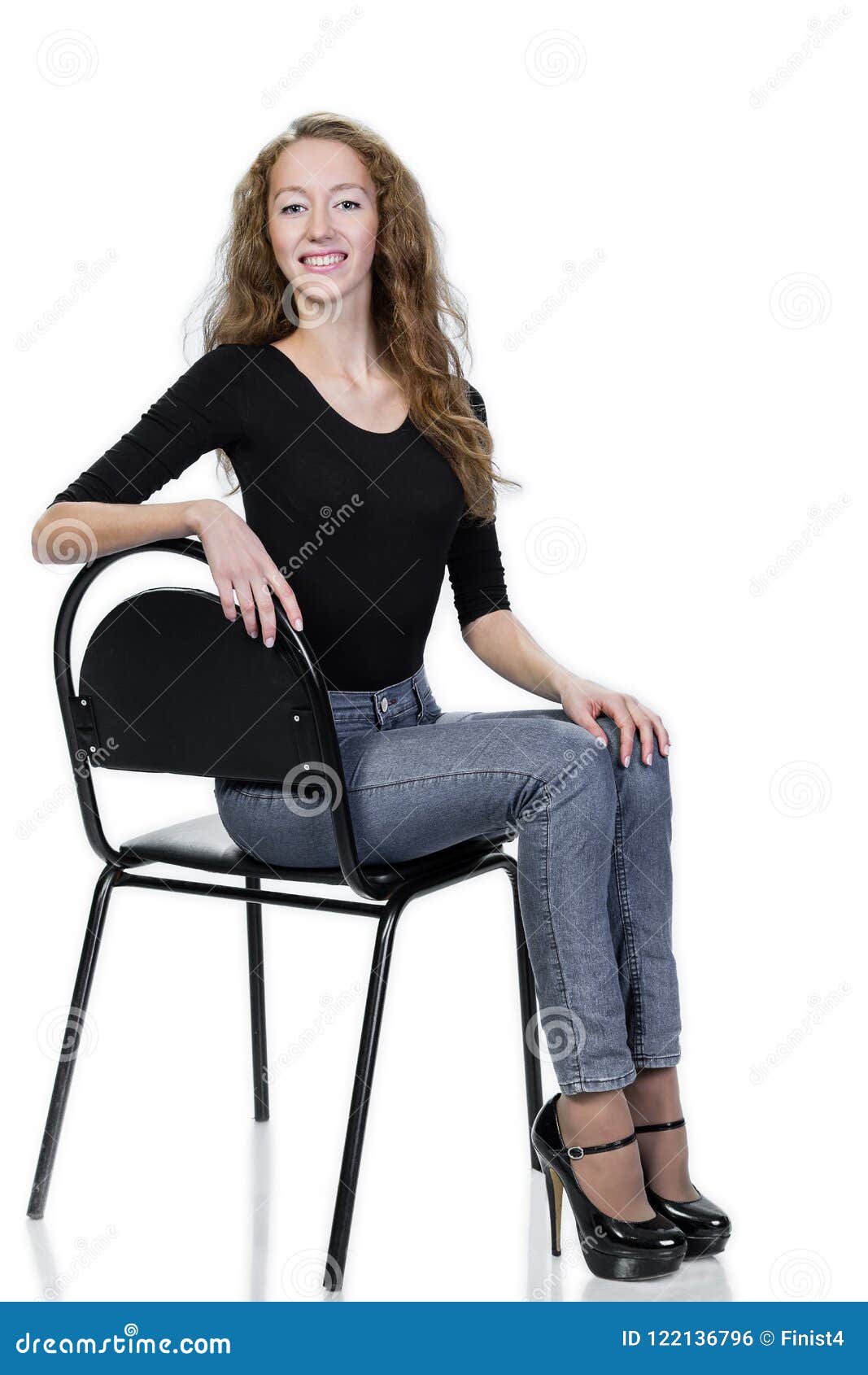 Beautiful Slender Blonde is Sitting on a Chair. Stock Photo - Image of ...