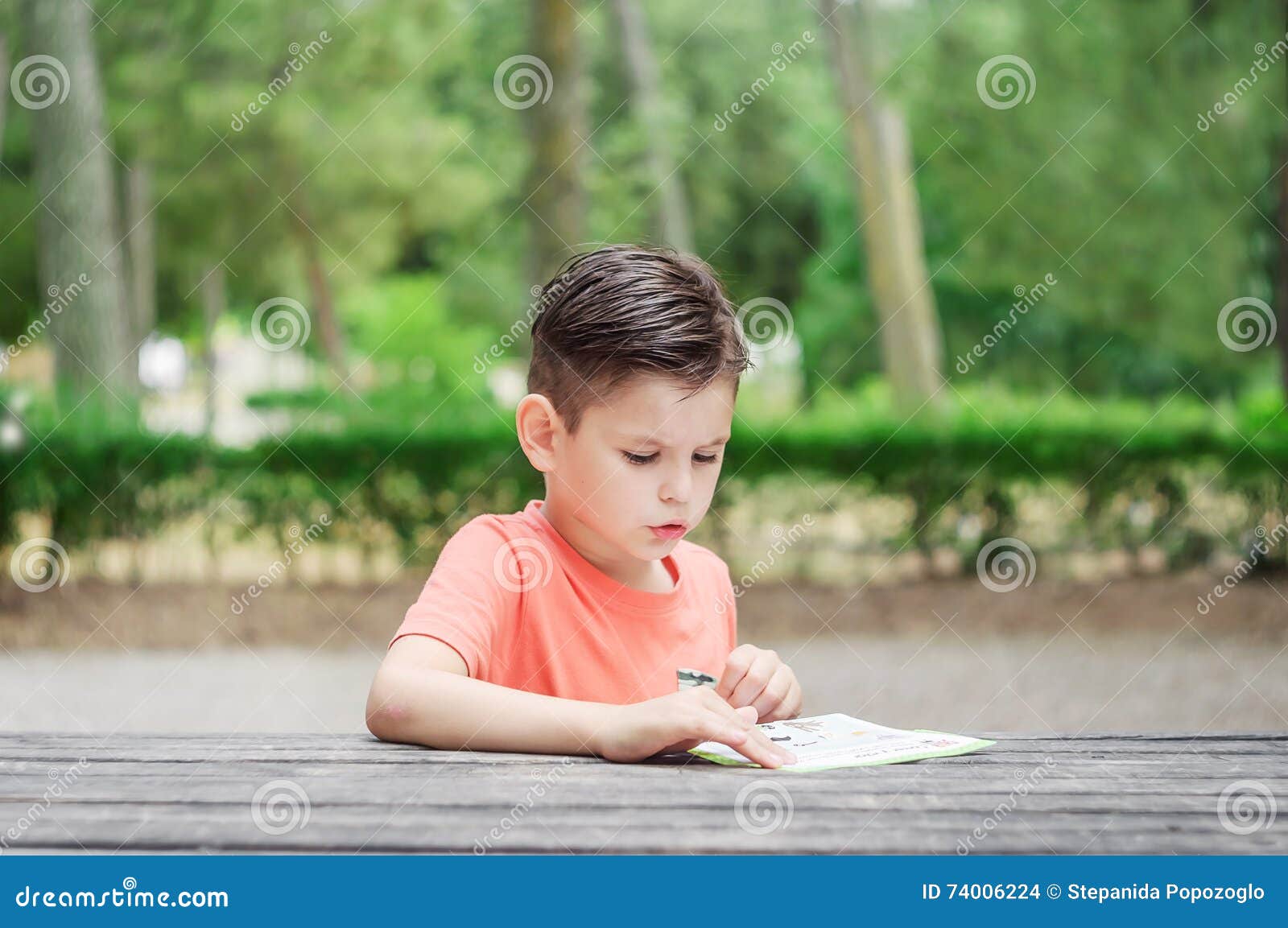 A Beautiful and Smart Boy Learning To Read. Stock Photo - Image of ...