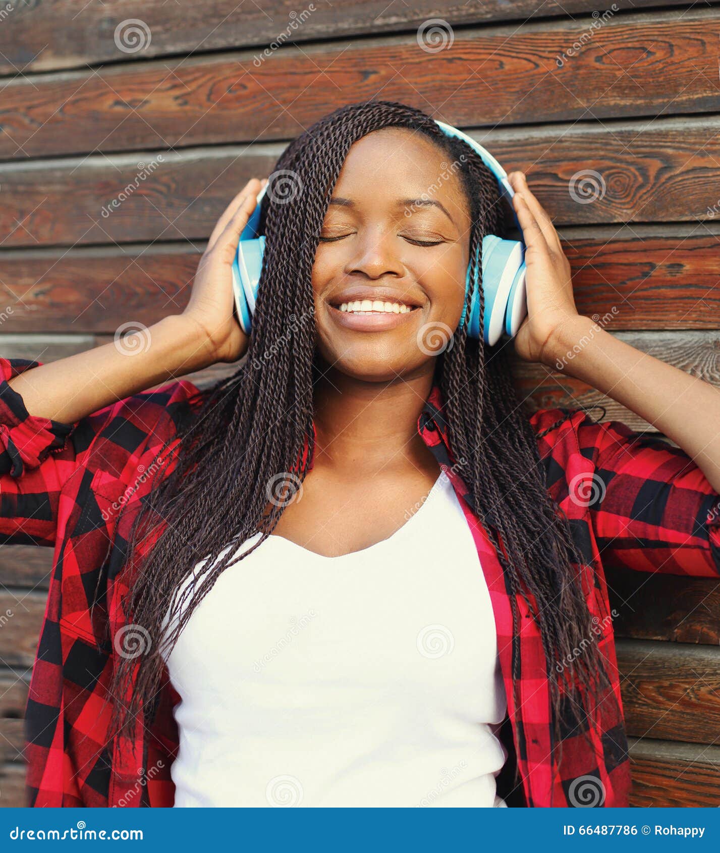 Beautiful Smiling African Woman With Headphones Enjoying Listens Music