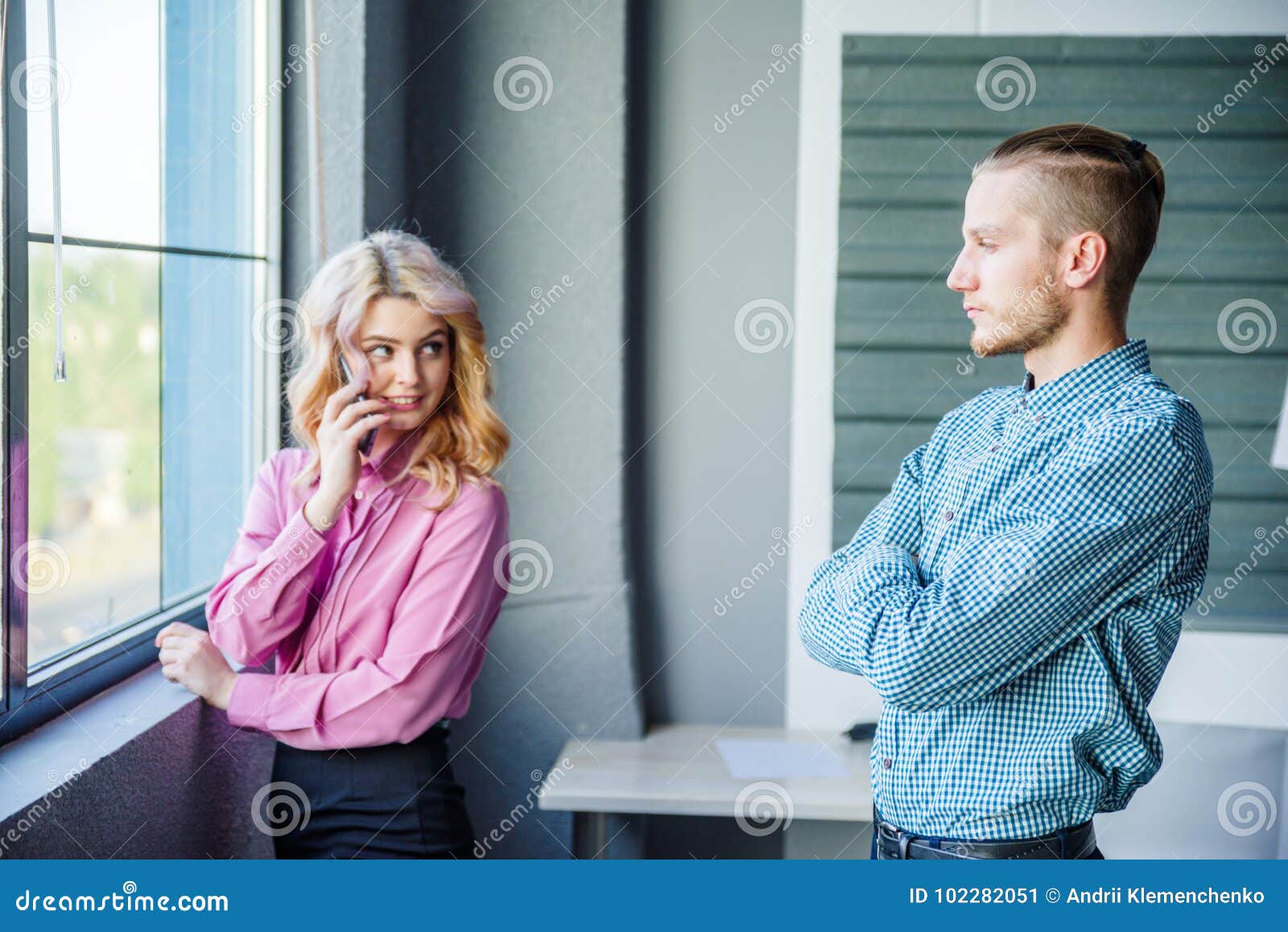 Beautiful Smiling Business Woman and Attractive Man in a Office ... Beautiful Smiling Business Woman and Attractive Man in a Office ...