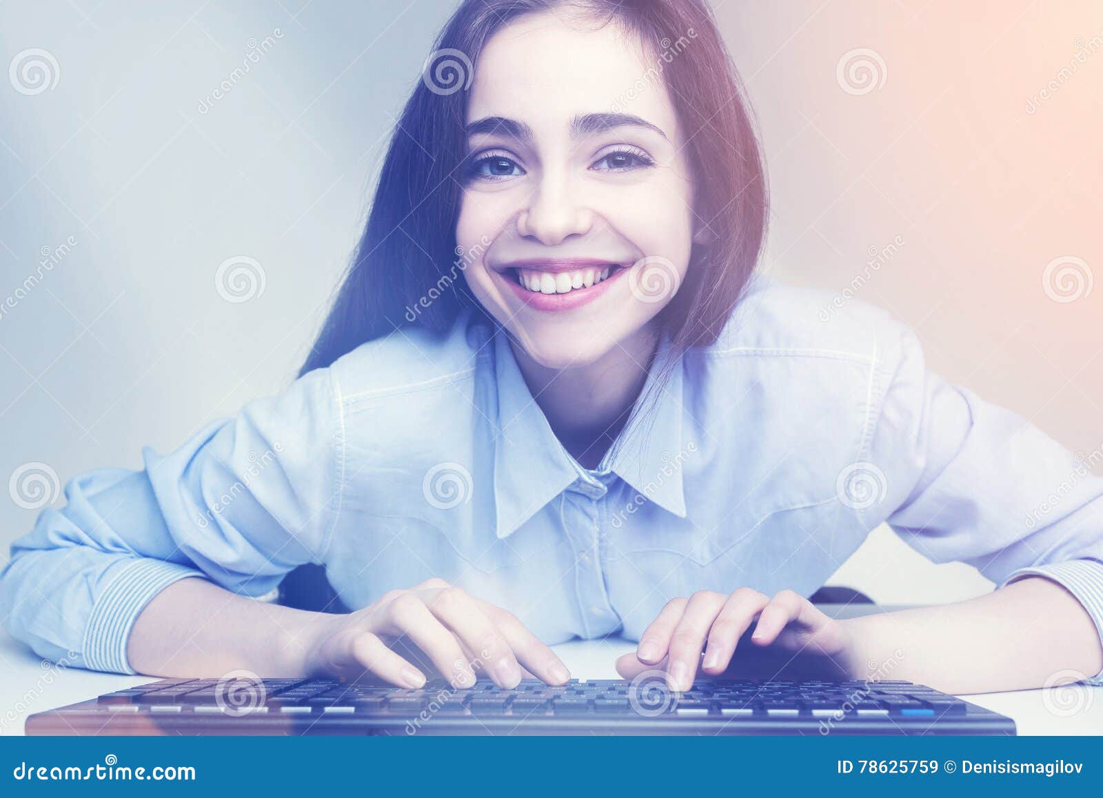 Beautiful Smiling Girl in Blue Using Keyboard Stock Image - Image of ...