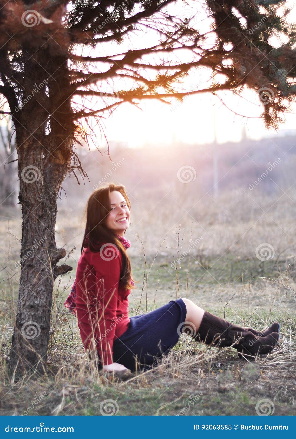 Beautiful Smiling Lady Sitting Under a Tree with Sunset on Background ...