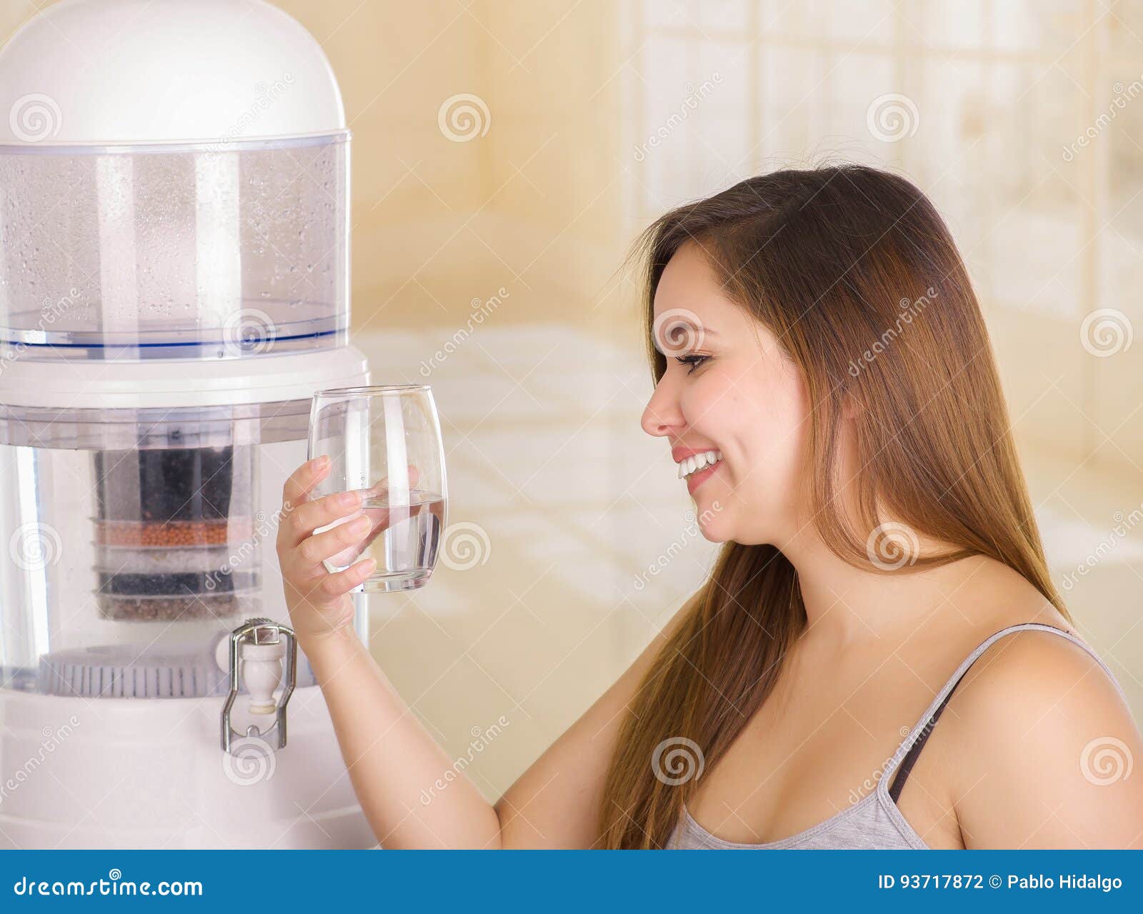 Beautiful Smiling Woman Holding a Glass of Water, with a Filter System ... Beautiful Smiling Woman Holding a Glass of Water, with a Filter System ...
