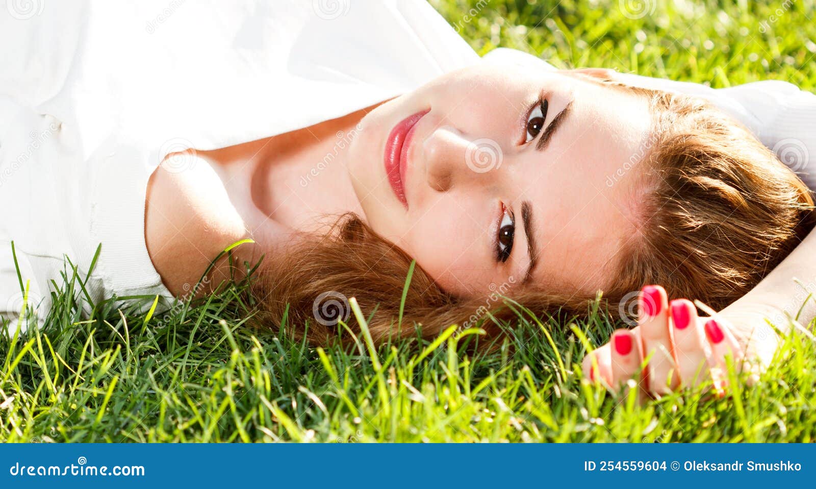 Beautiful Smiling Woman Lying On A Grass Outdoor She Is Absolutely