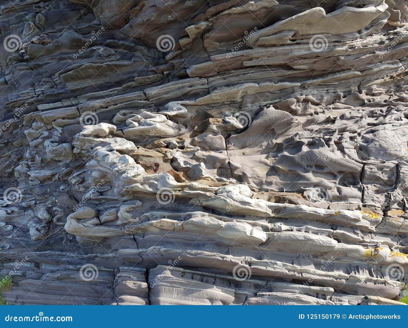 A Big Rock On The Side Of A Hill With Blurry Foggy Mountain Background ...
