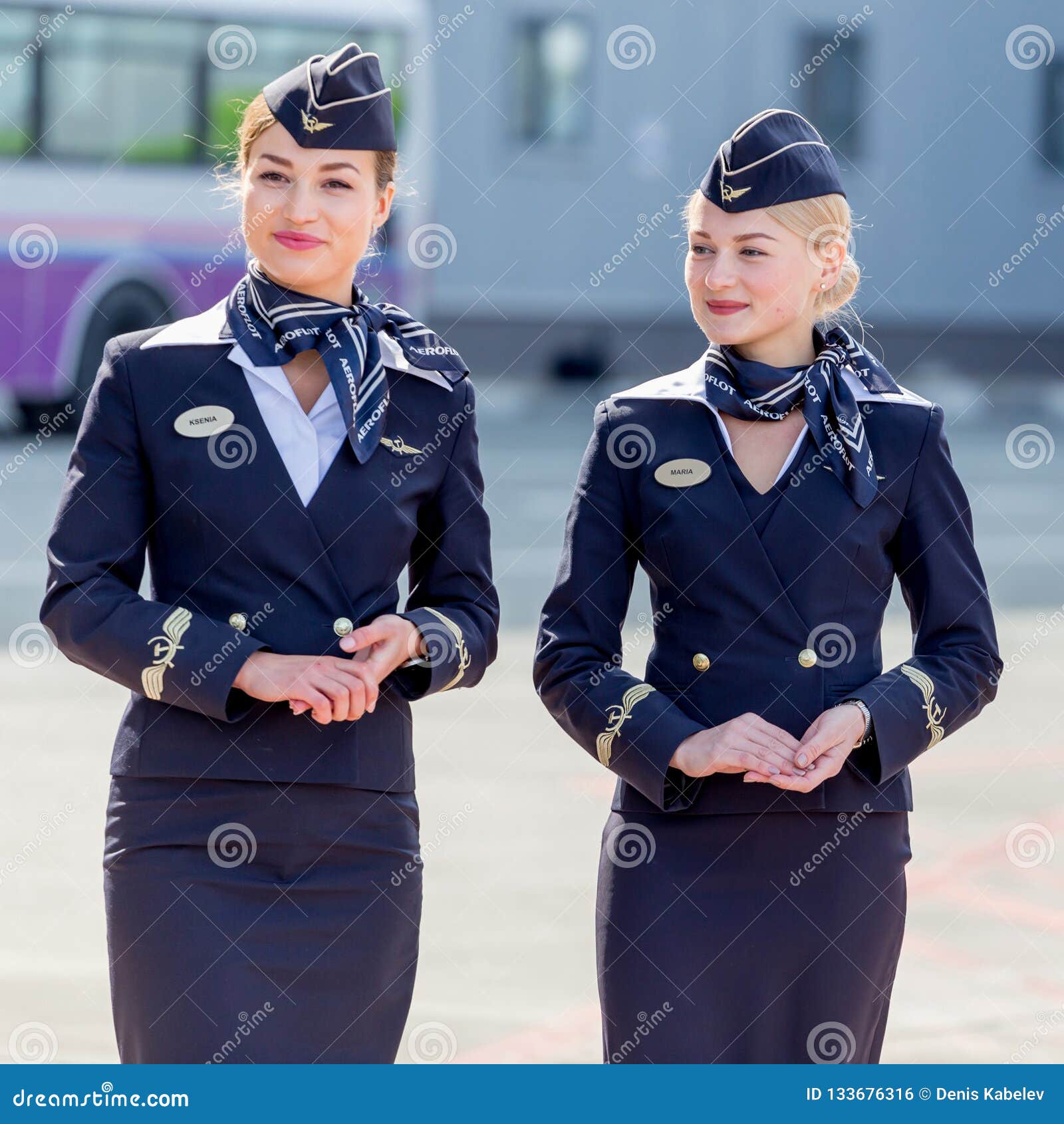 Beautiful Stewardesses Dressed In Official Dark Blue Uniform Of Aeroflot Airlines On Airfield