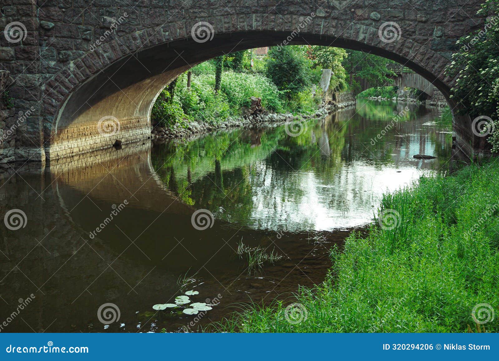 A Beautiful Stone Bridge Over a Canal Stock Photo - Image of leaf ...