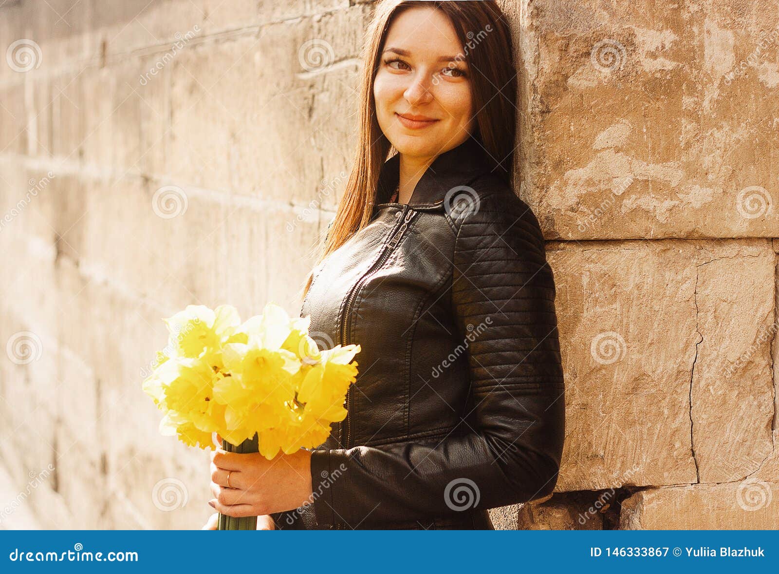 Beautiful Portrait Of Brunette Woman Holding Yellow Spring Flowers