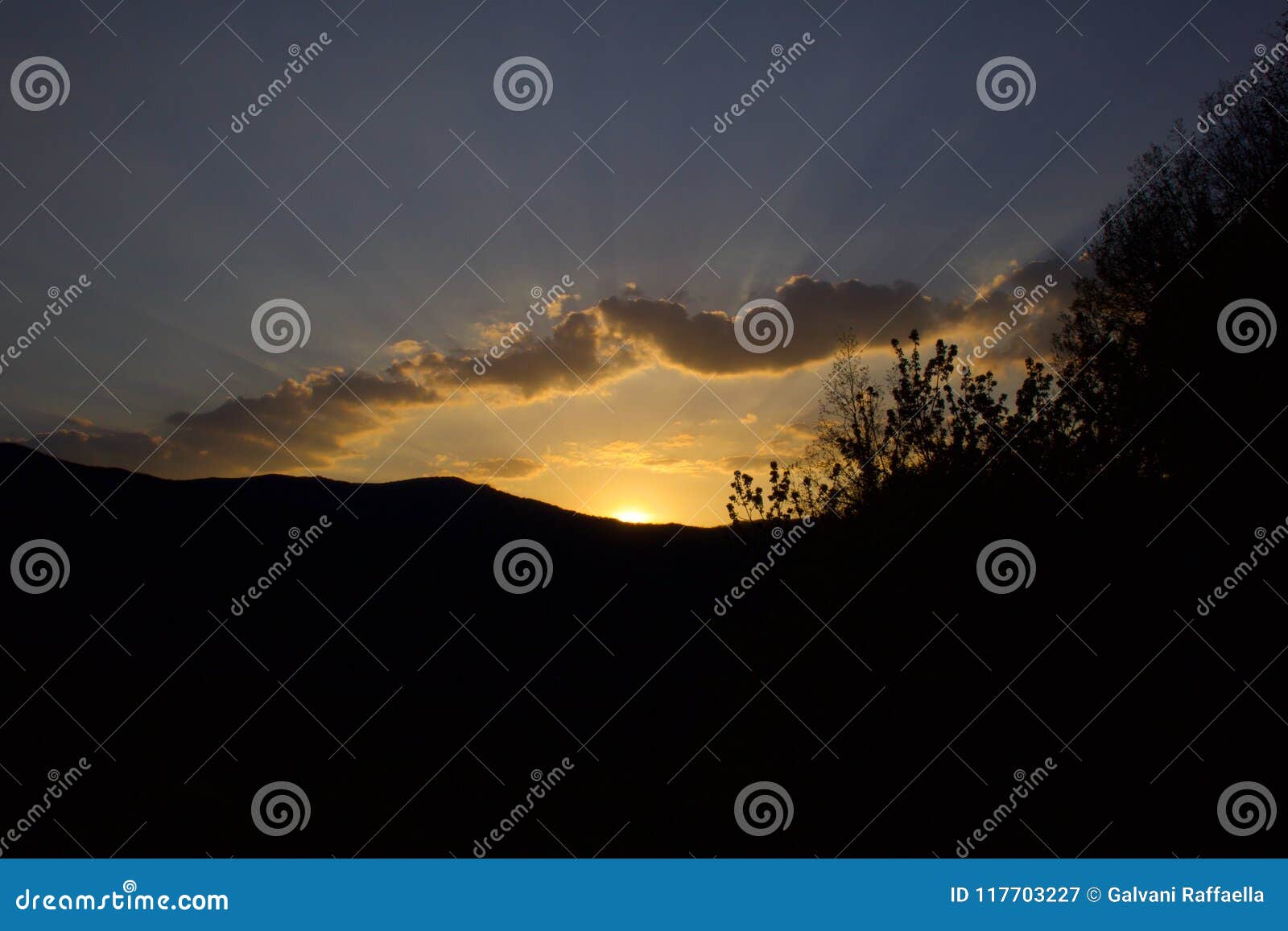 Beautiful Sunset on the Hills with Sun Rays Breaking through Th Stock ...