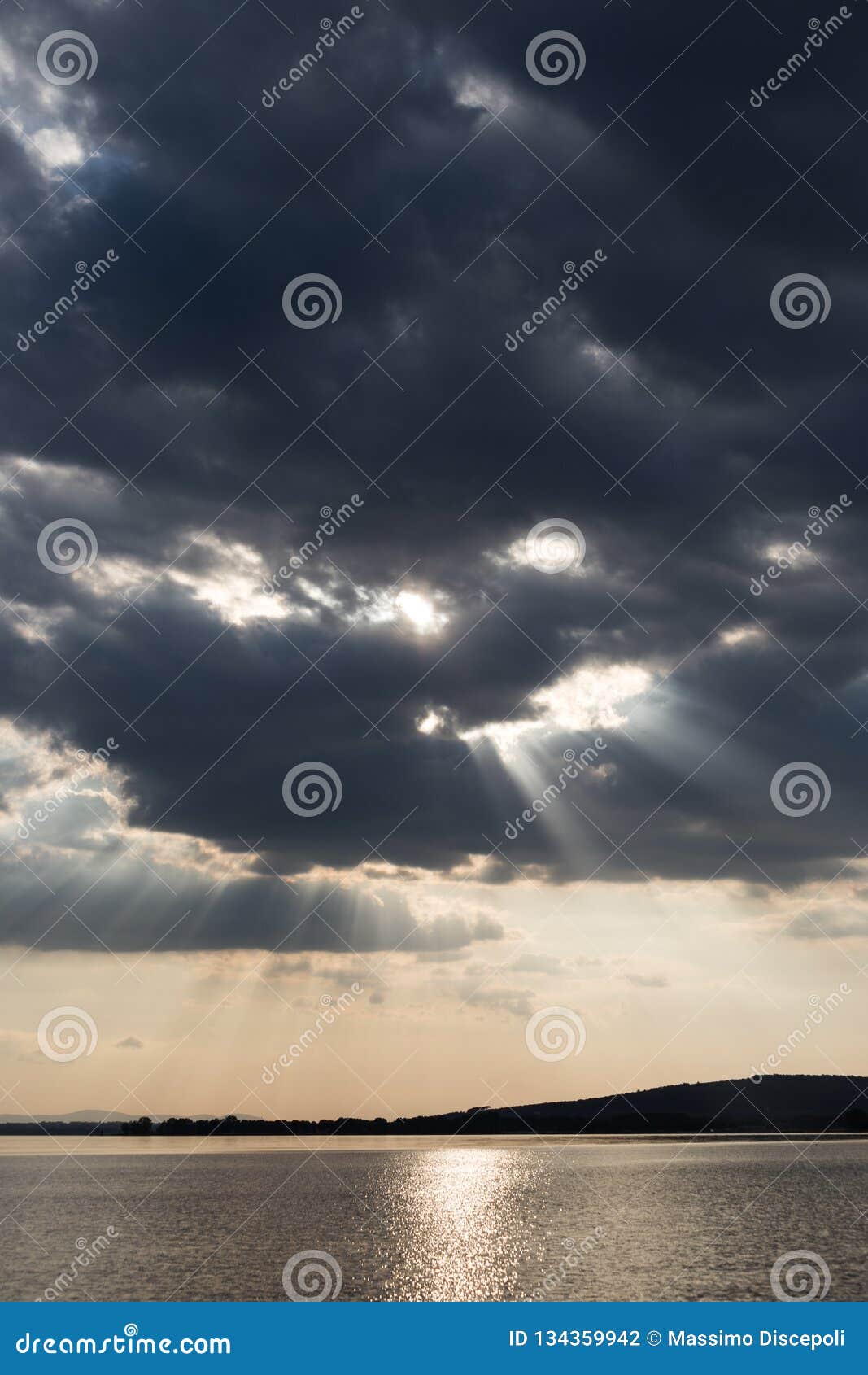 Beautiful Sunset on a Lake, with Sunrays Coming Down Under an Overcast ...