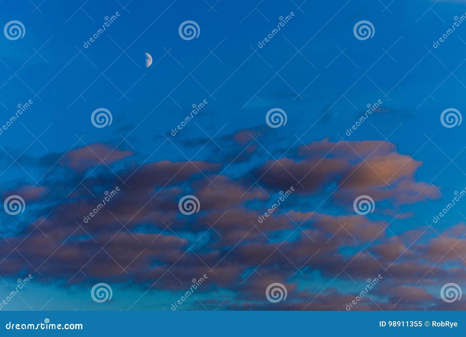 Beautiful Sunset with Orange Clouds, Deep Blue Sky and Moon Stock Image ...