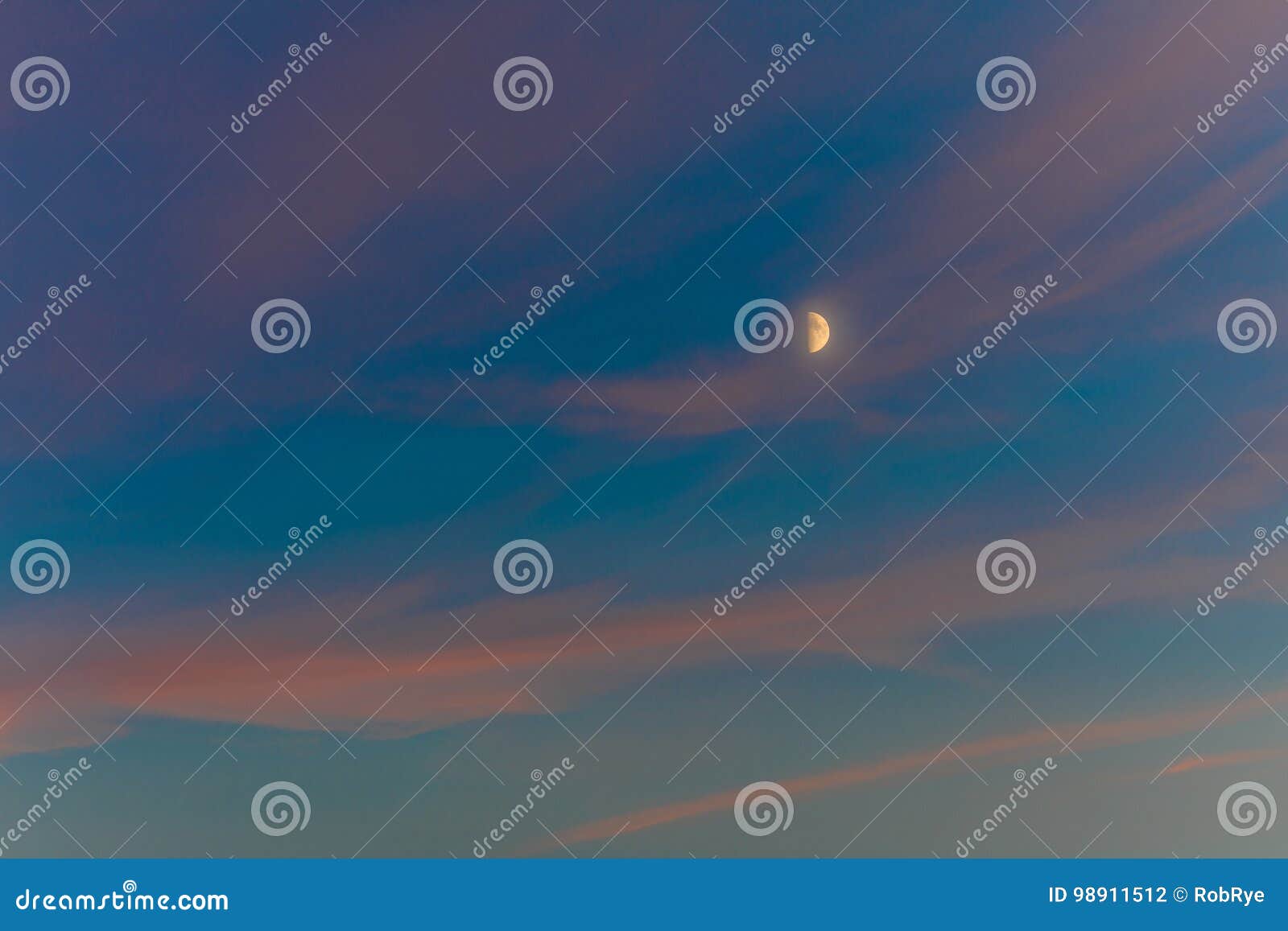 Beautiful Sunset with Orange Clouds, Deep Blue Sky and Moon Stock Photo ...