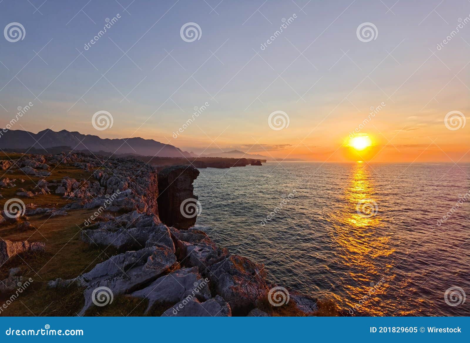 Beautiful Sunset View Over a Sunray Reflection on a Calm Seawater Stock ...