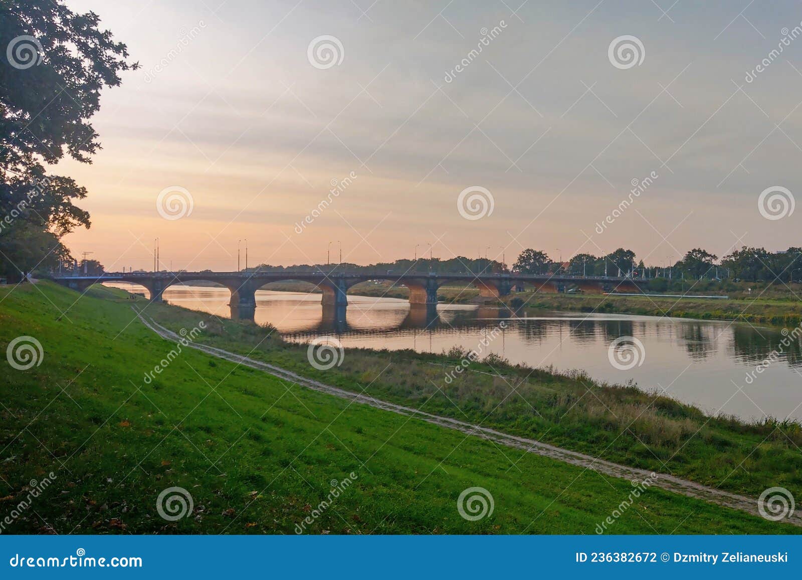 Beautiful Sunset View on the River Bank. View of the Bridge. Stock ...