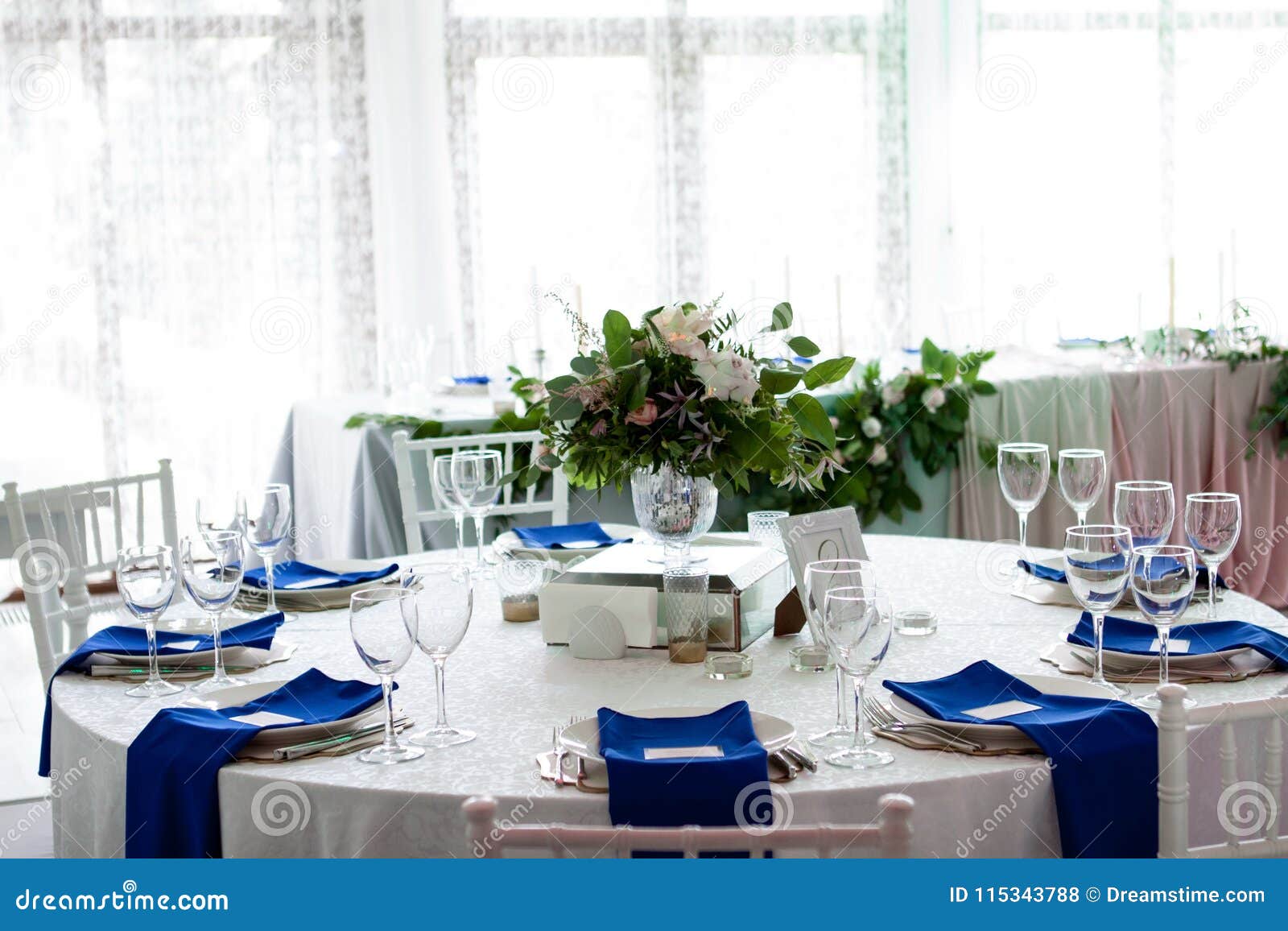 Beautiful Table Setting with a White Tablecloth and Blue Napkins Stock ...