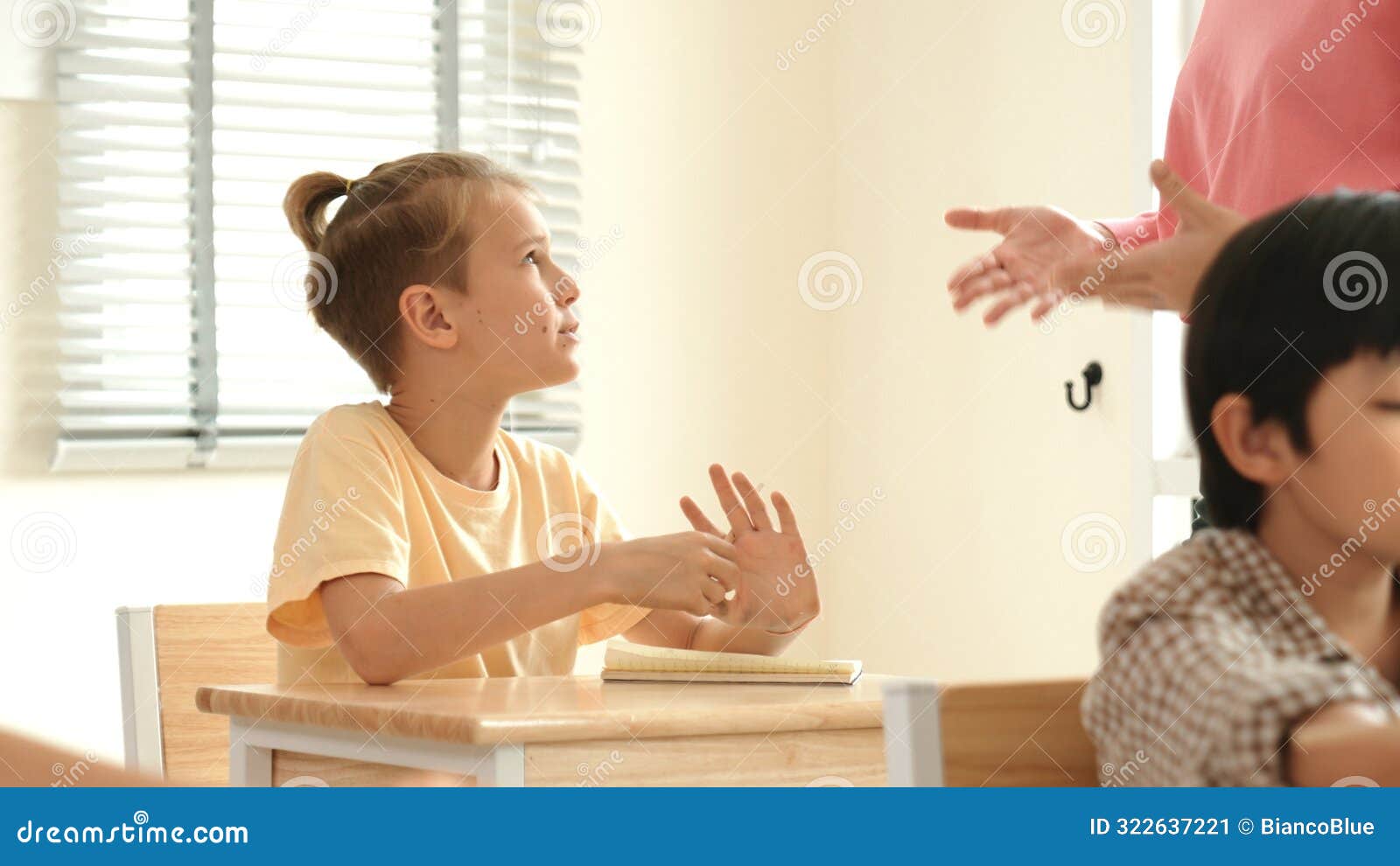 Beautiful Teacher Explaining Test while Caucasian Boy Doing Classwork ...