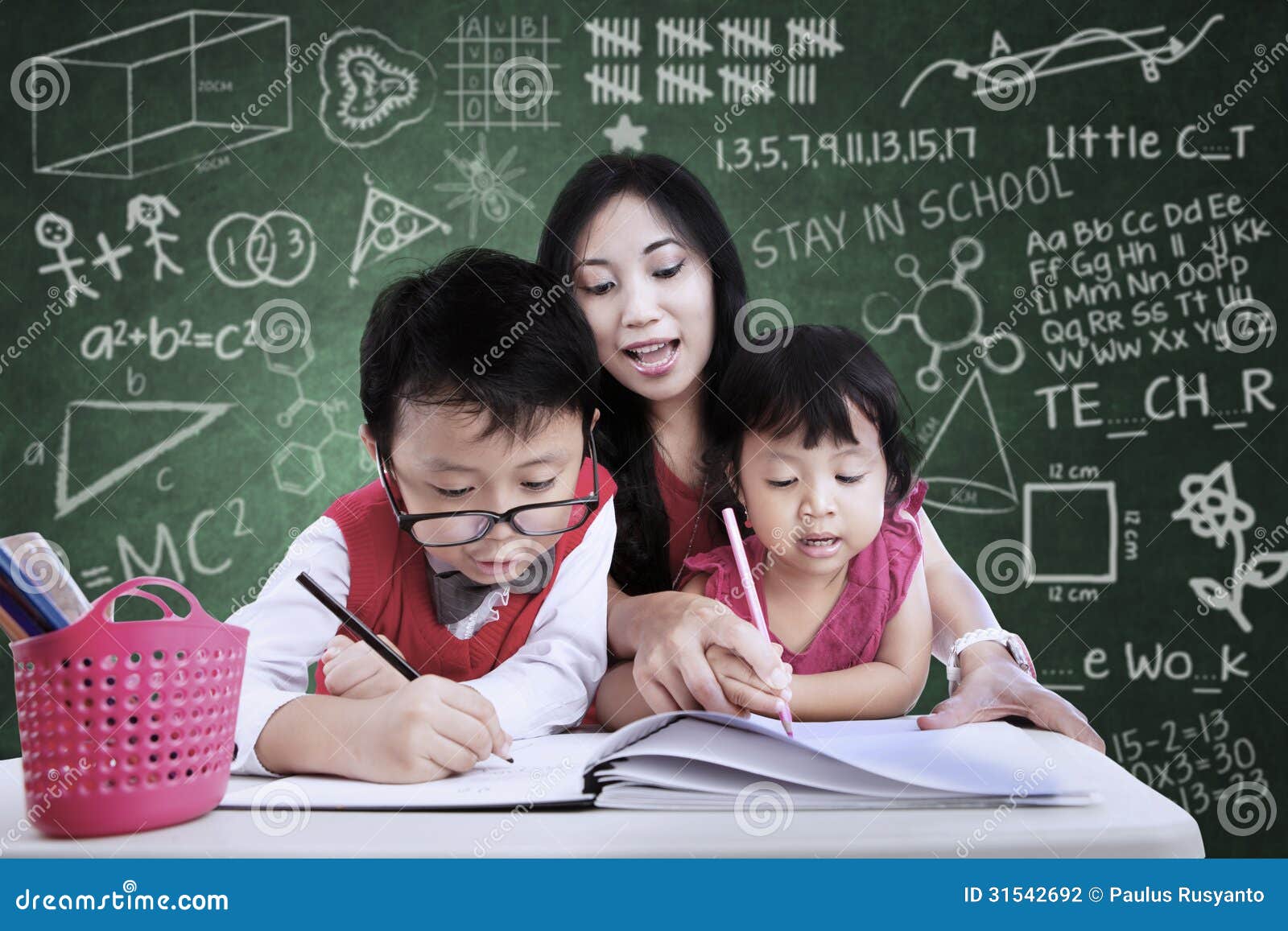 Beautiful Teacher Help Children To Write in Class Stock Photo - Image ...