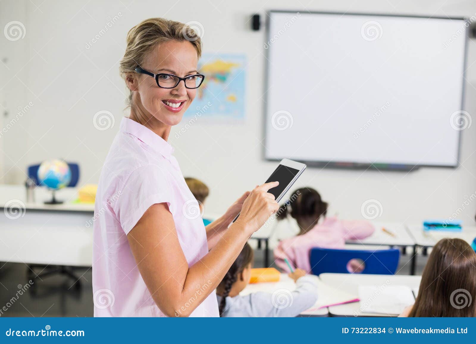 Beautiful Teacher Looking at Camera with Tablet Computer Stock Photo ...