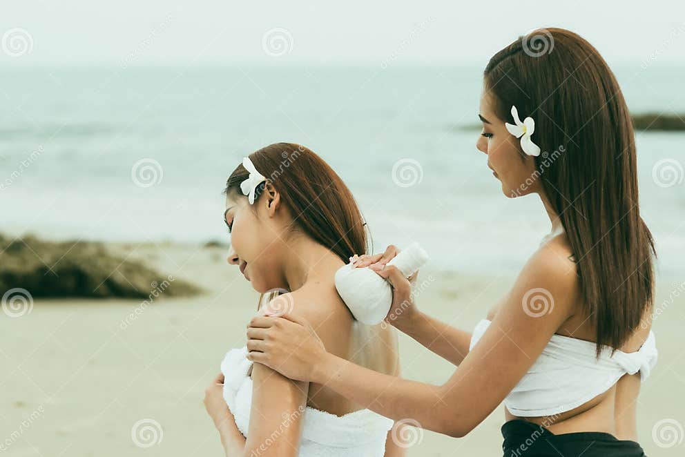 Beautiful Thai Woman Massage With Herbal Ball Spa On The Beach Stock
