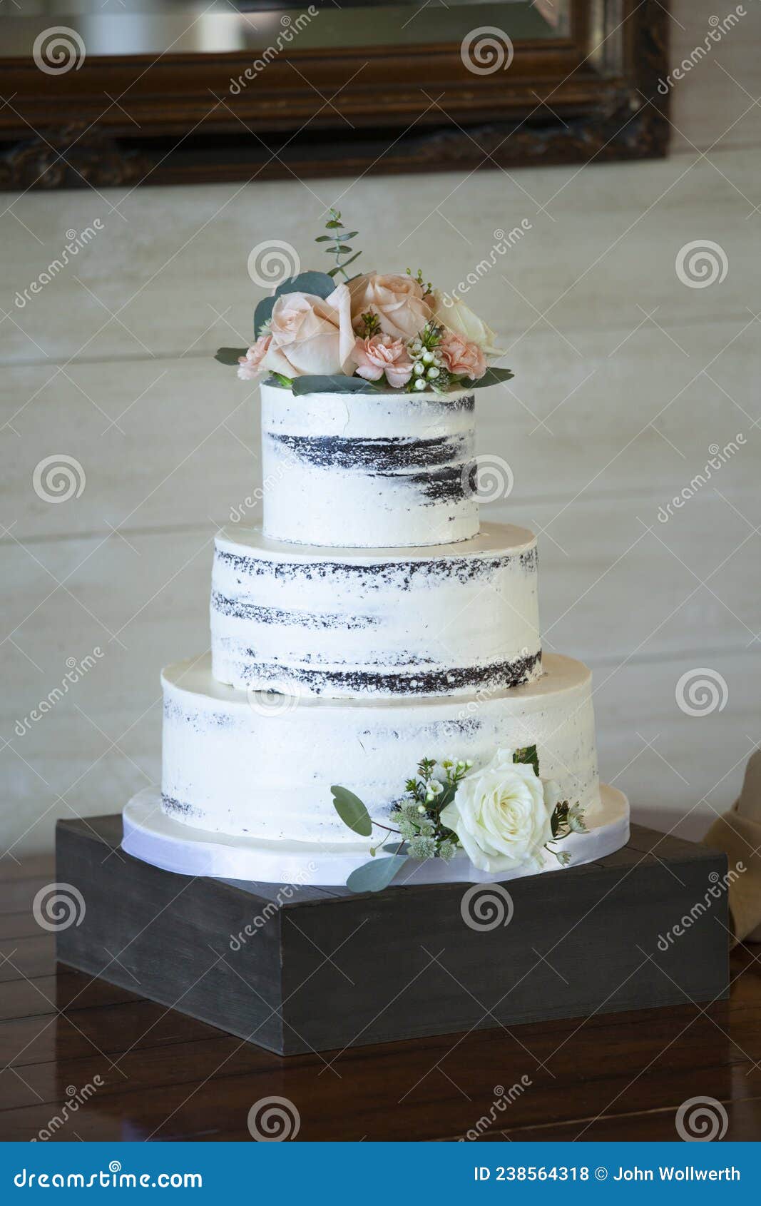 Beautiful Three Tiered Wedding Cake with Roses and Dirty Icing Stock ...