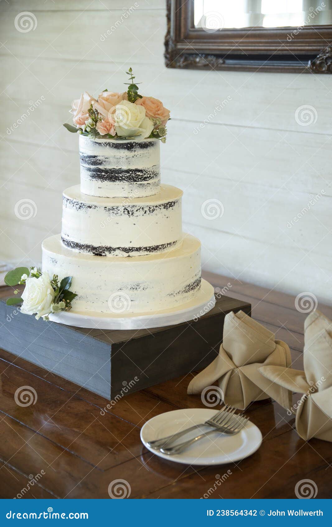 Beautiful Three Tiered Wedding Cake with Roses and Dirty Icing Stock ...
