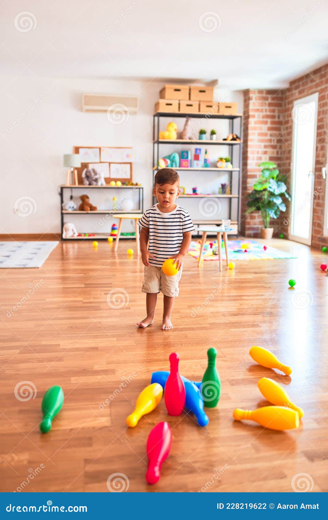 Beautiful Toddler Boy Playing Bowling at Kindergarten Stock Photo ...