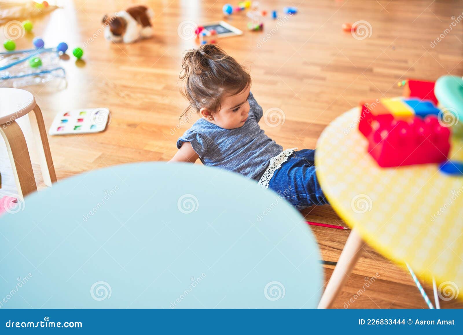 Beautiful Toddler Lying Down on the Floor at Kindergarten Stock Photo ...