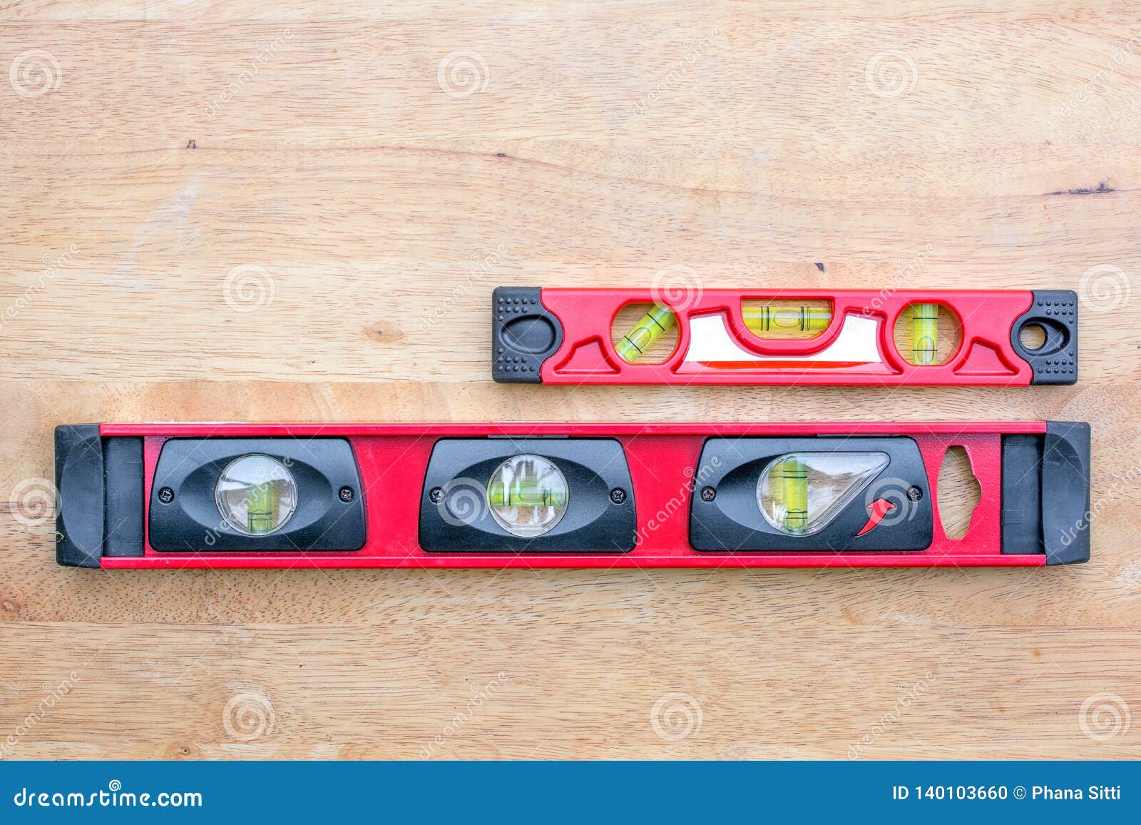 Beautiful Two Red Builder Level on the Wooden Table Background Stock ...