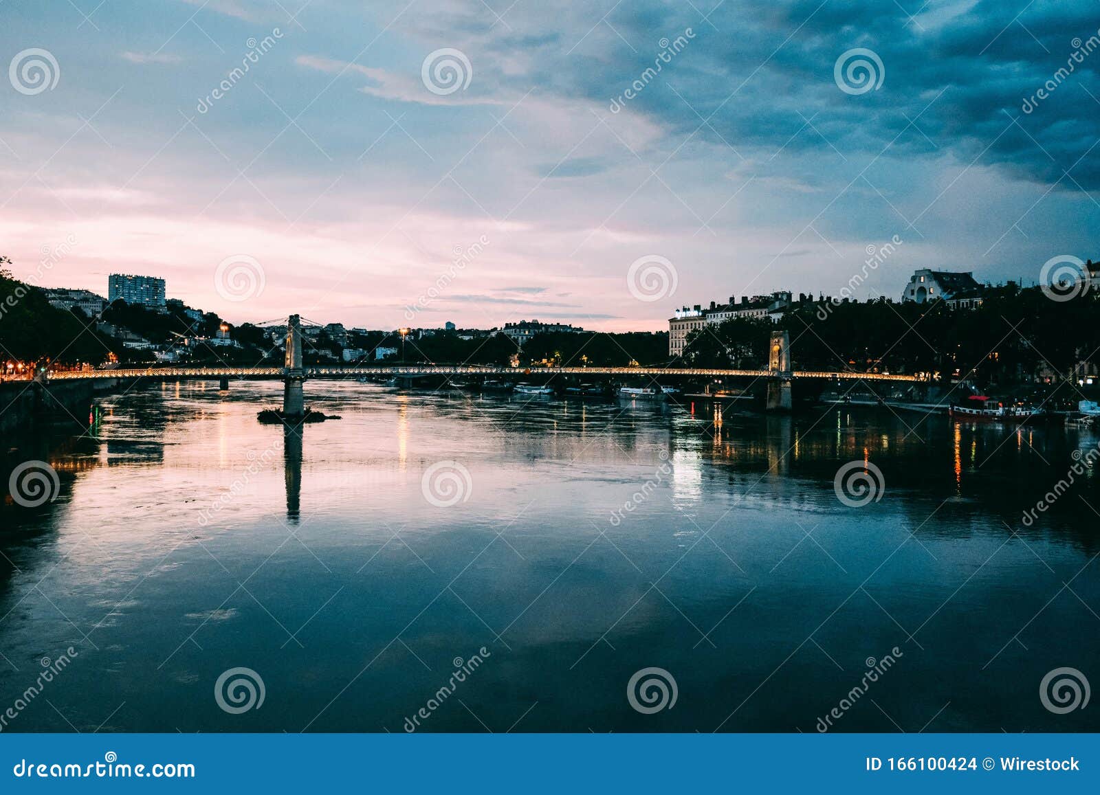 Beautiful View of a Bridge Going Over a River Surrounded by Buildings ...