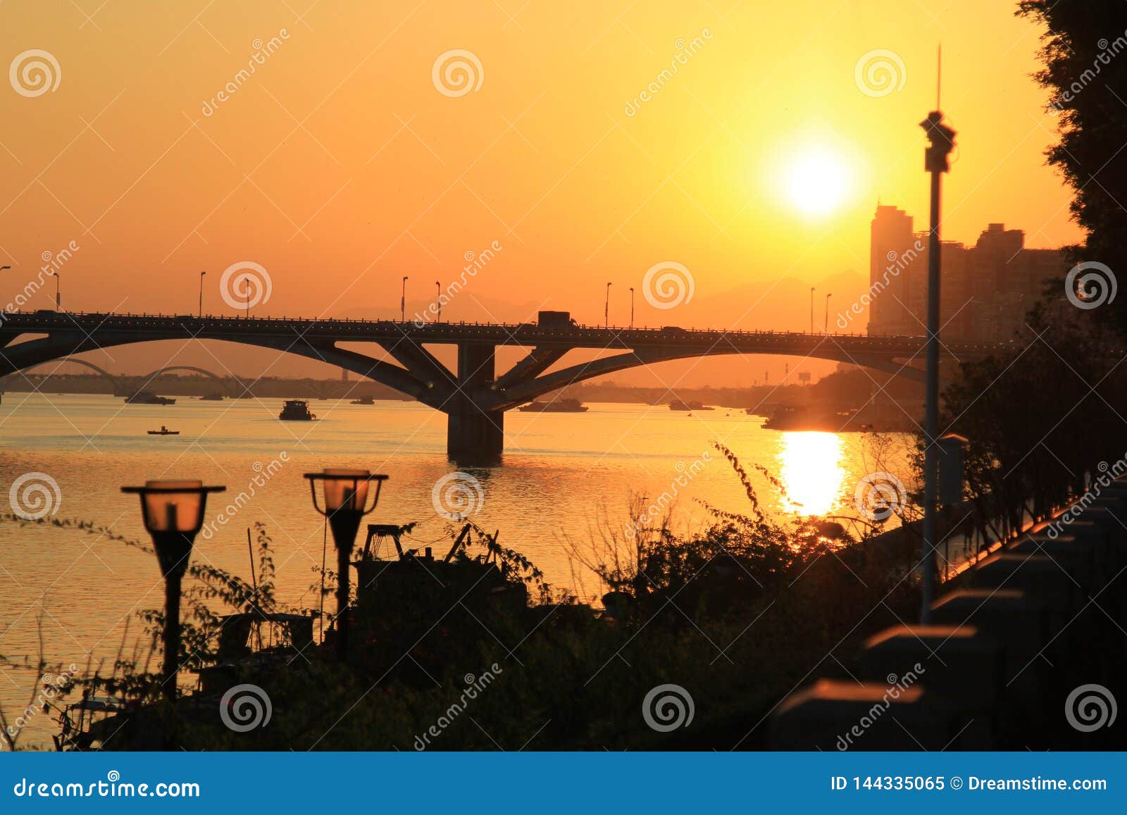 Bridge in the sunset stock image. Image of riverside - 144335065