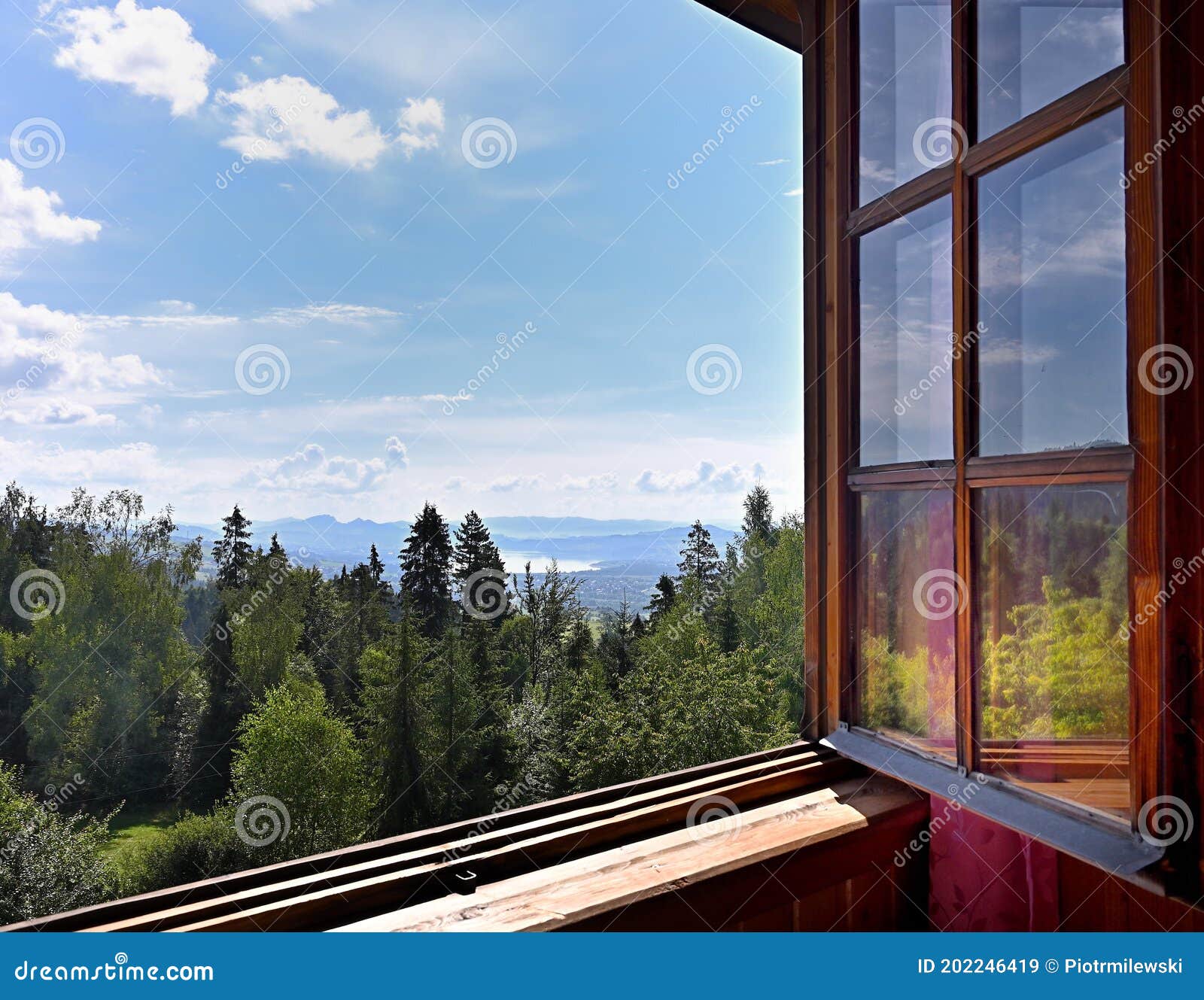 Beautiful View on Green Forest, Blue Sky and Mountains through a Wooden ...