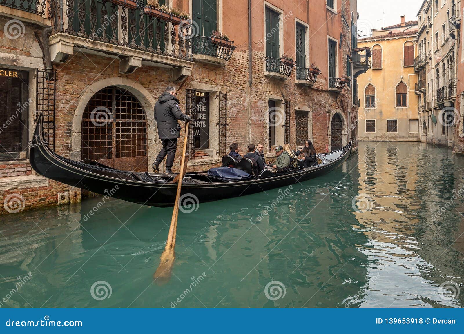 Beautiful View Of Traditional Gondolas With Tourist On Famous Canal