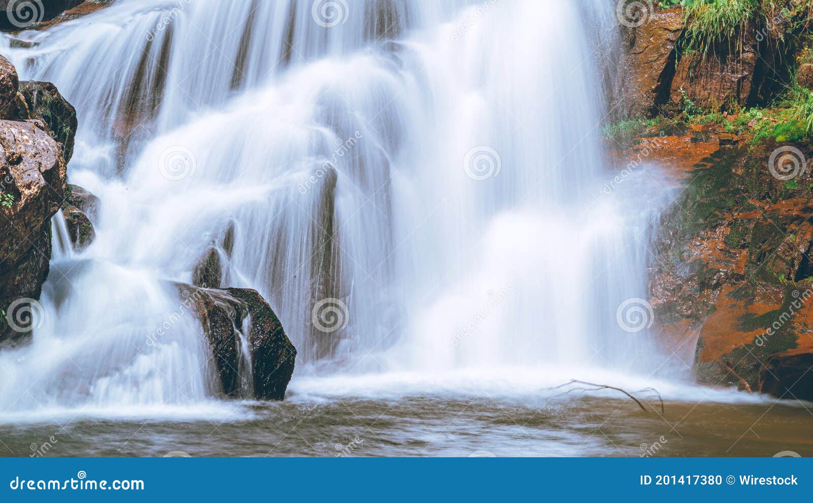Beautiful View of the Waterfall Streaming Down from the Rocks into the ...