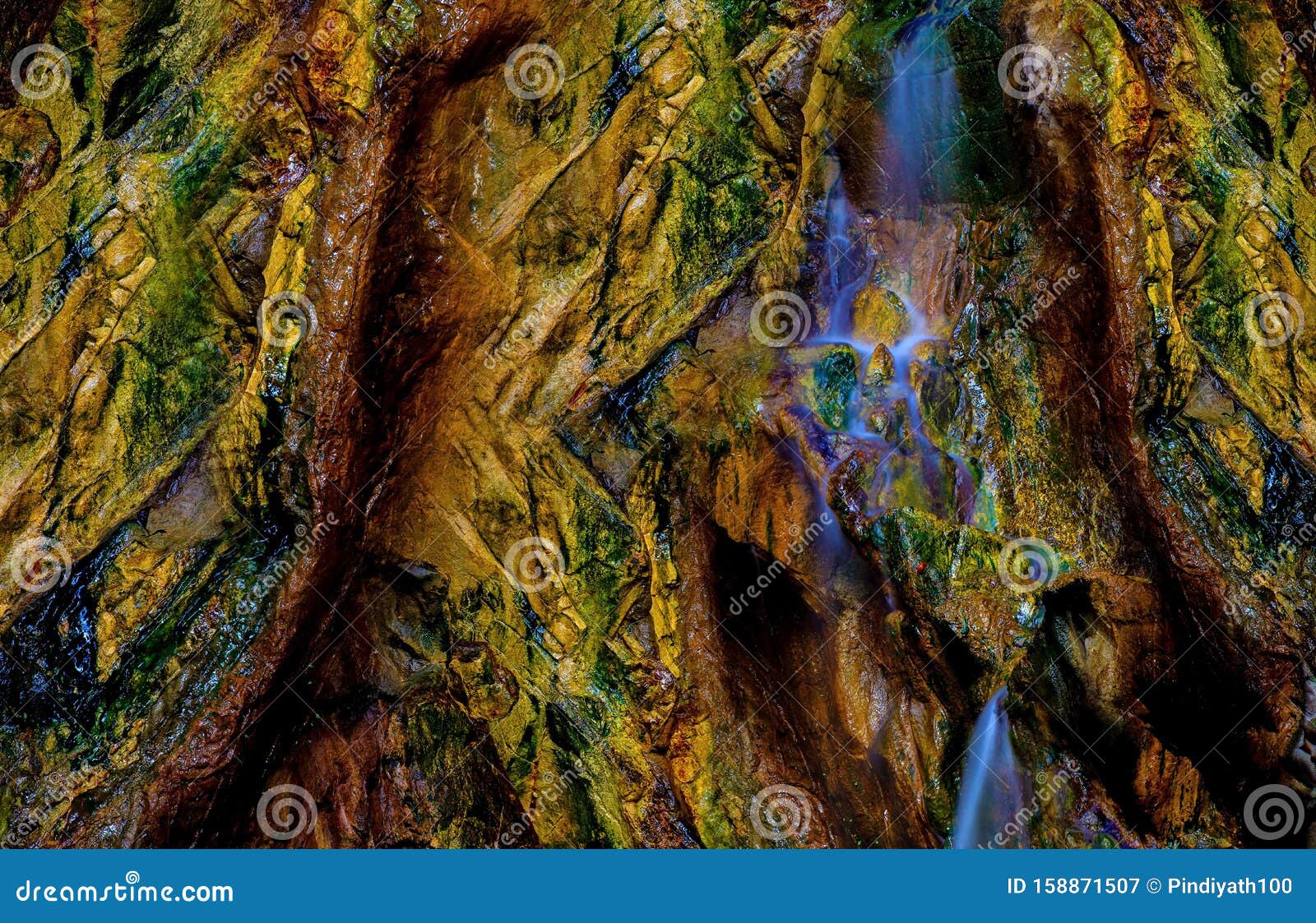 Small Waterfall Inside a Cave Wall with Wet Textures of Rocks Stock ...