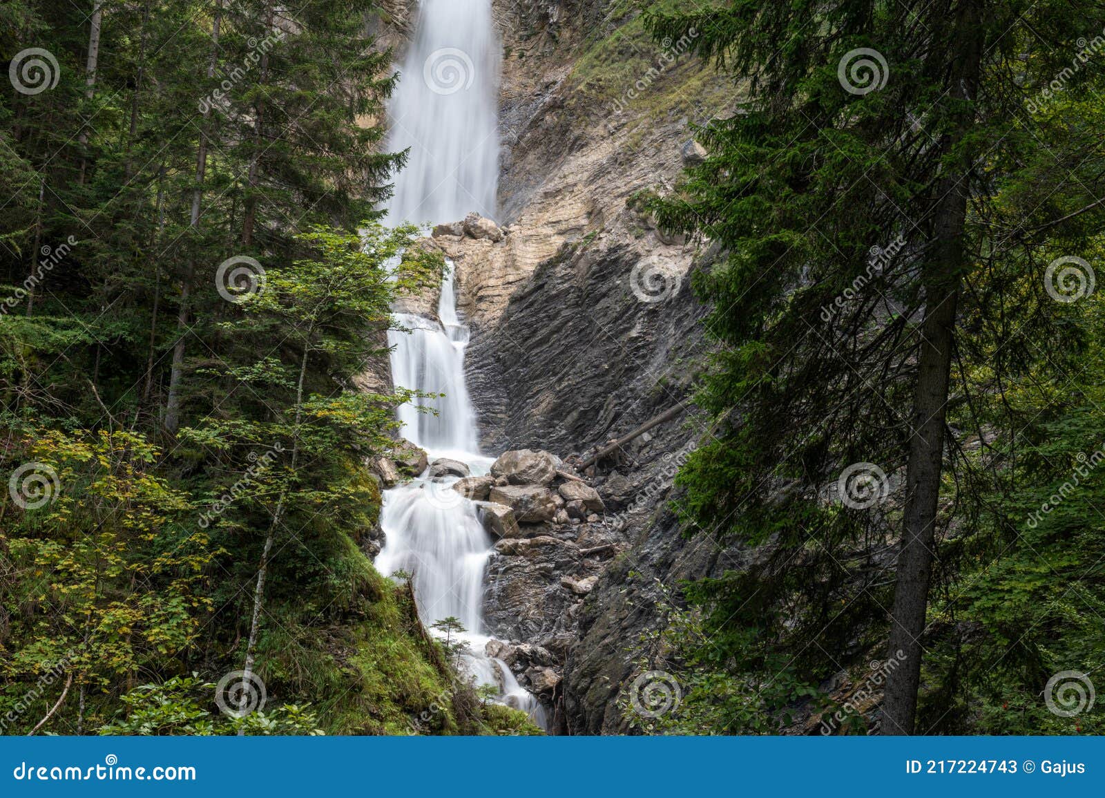 Beautiful Waterfall Falling Over the Rocks in a Green Forest Stock ...