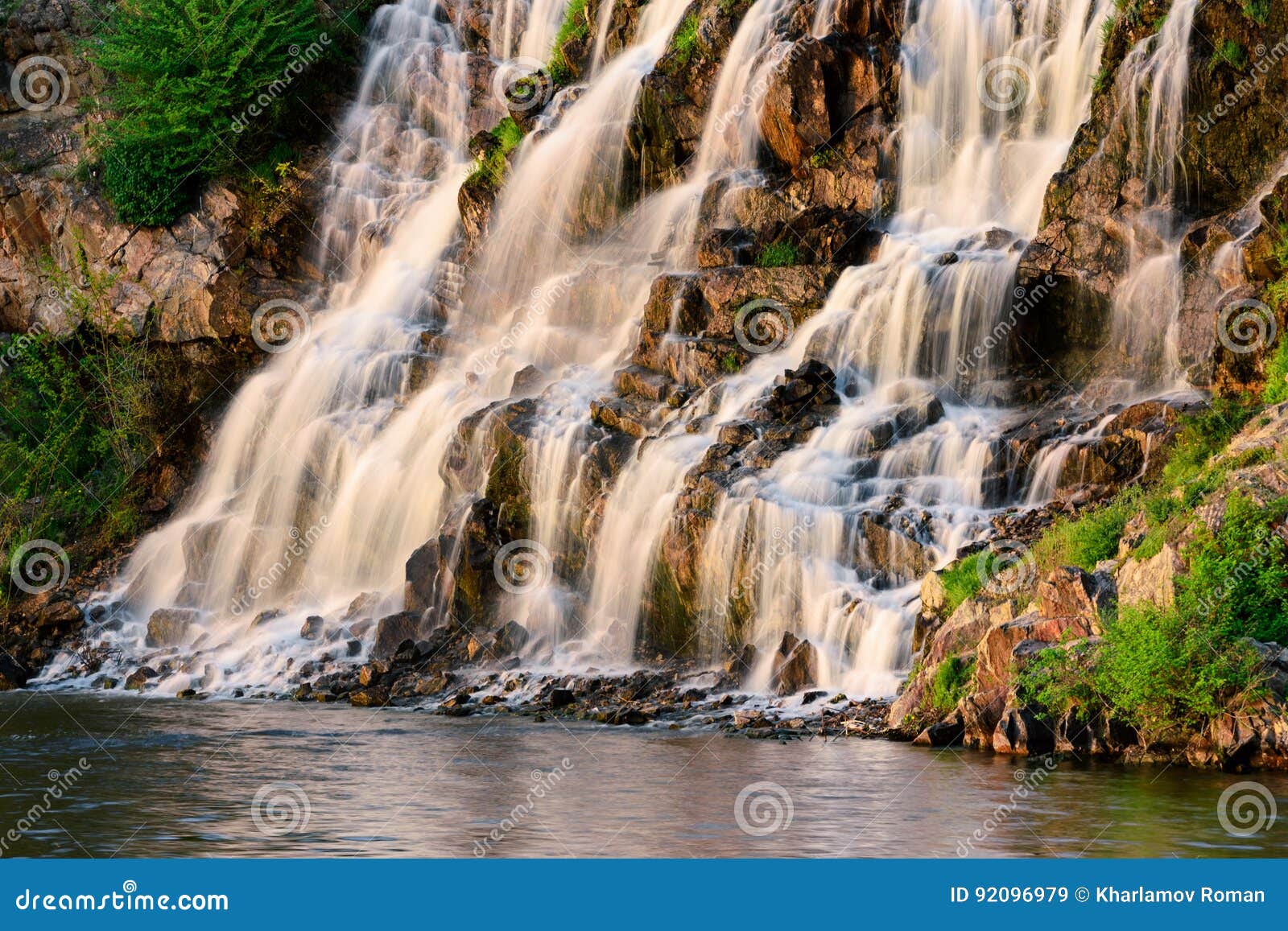 Beautiful Waterfall at Sunset in the Rays of the Setting Sun II Stock ...