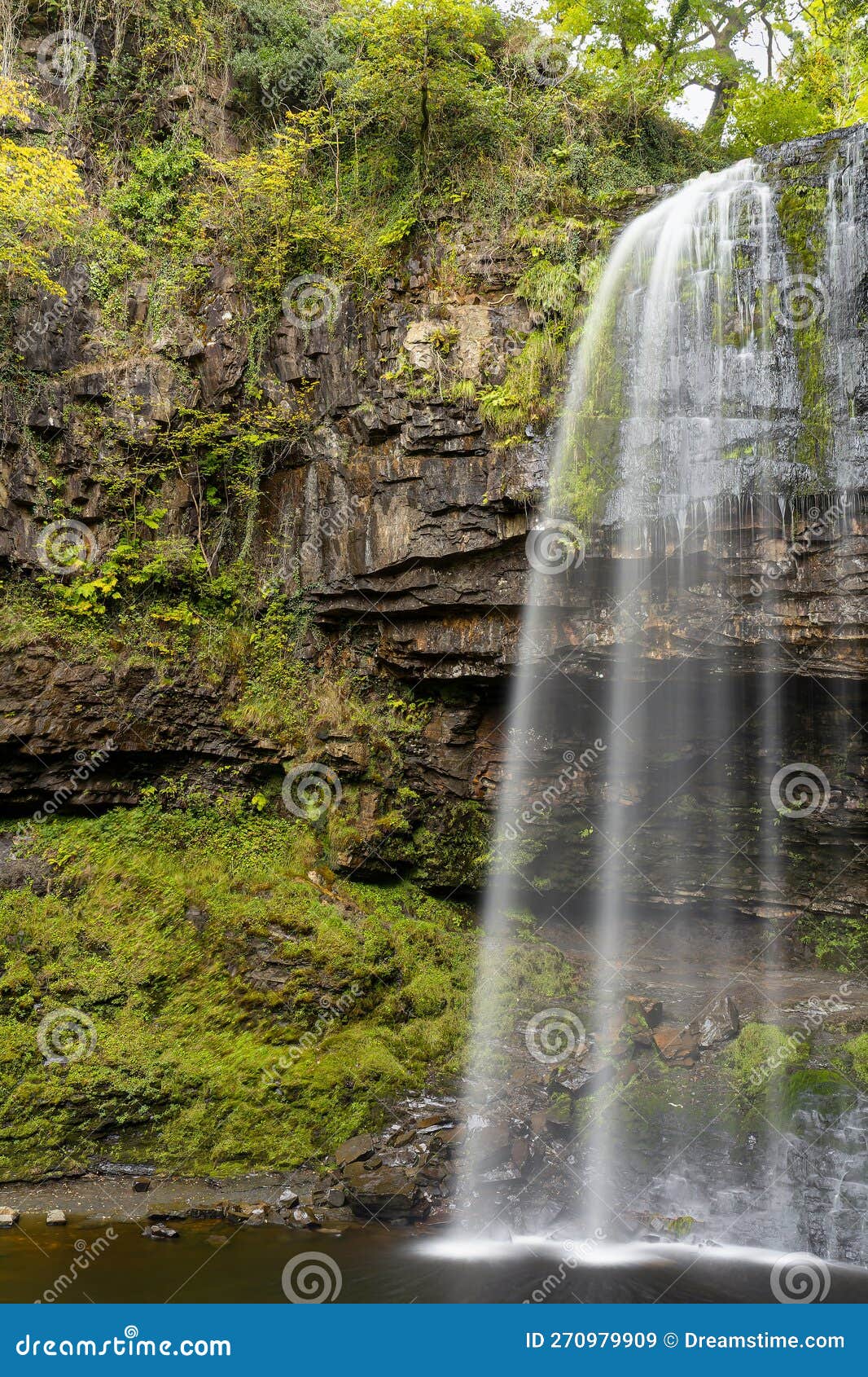 Beautiful Waterfall Surrounded by Green Foliage in a Small Valley ...